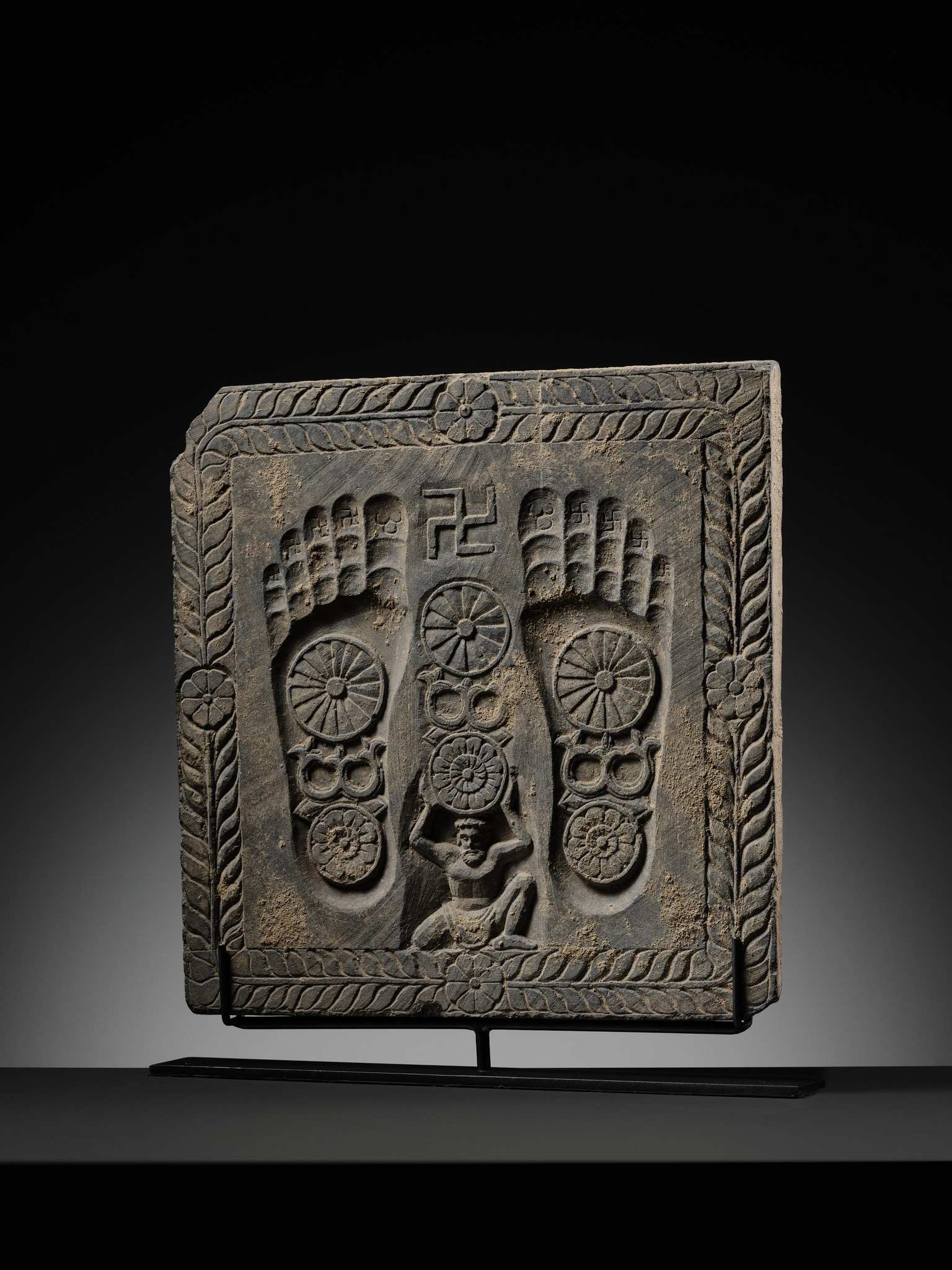 Lot 186 - A RARE GRAY SCHIST RELIEF OF THE FOOTPRINTS