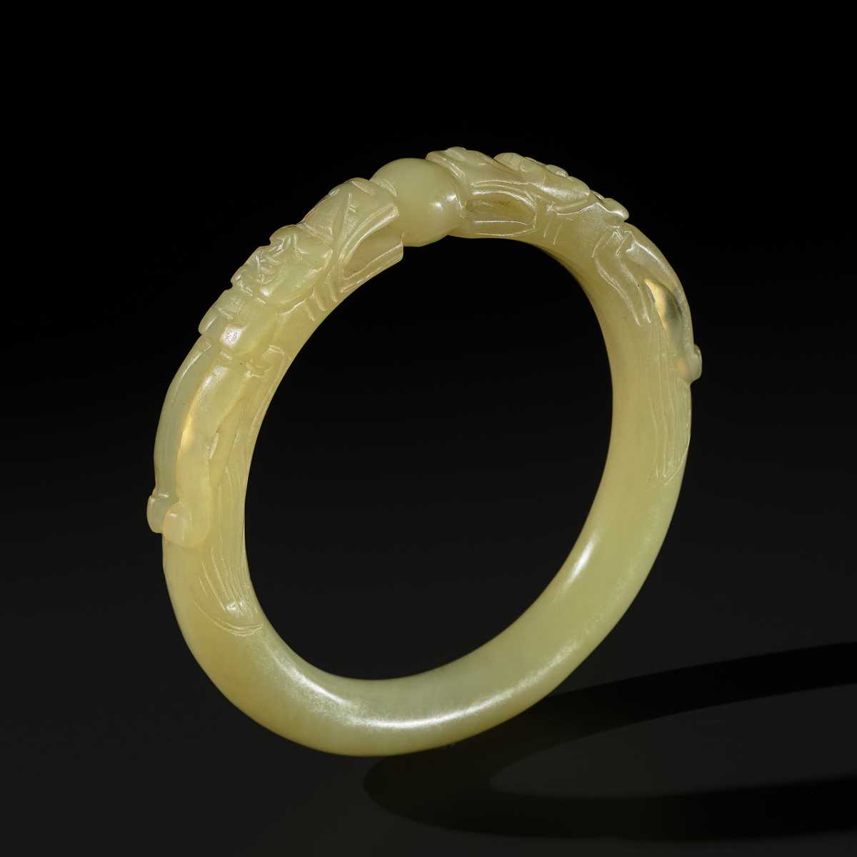 Lot 456 - A YELLOW JADE ‘DRAGON’ BANGLE, QING DYNASTY