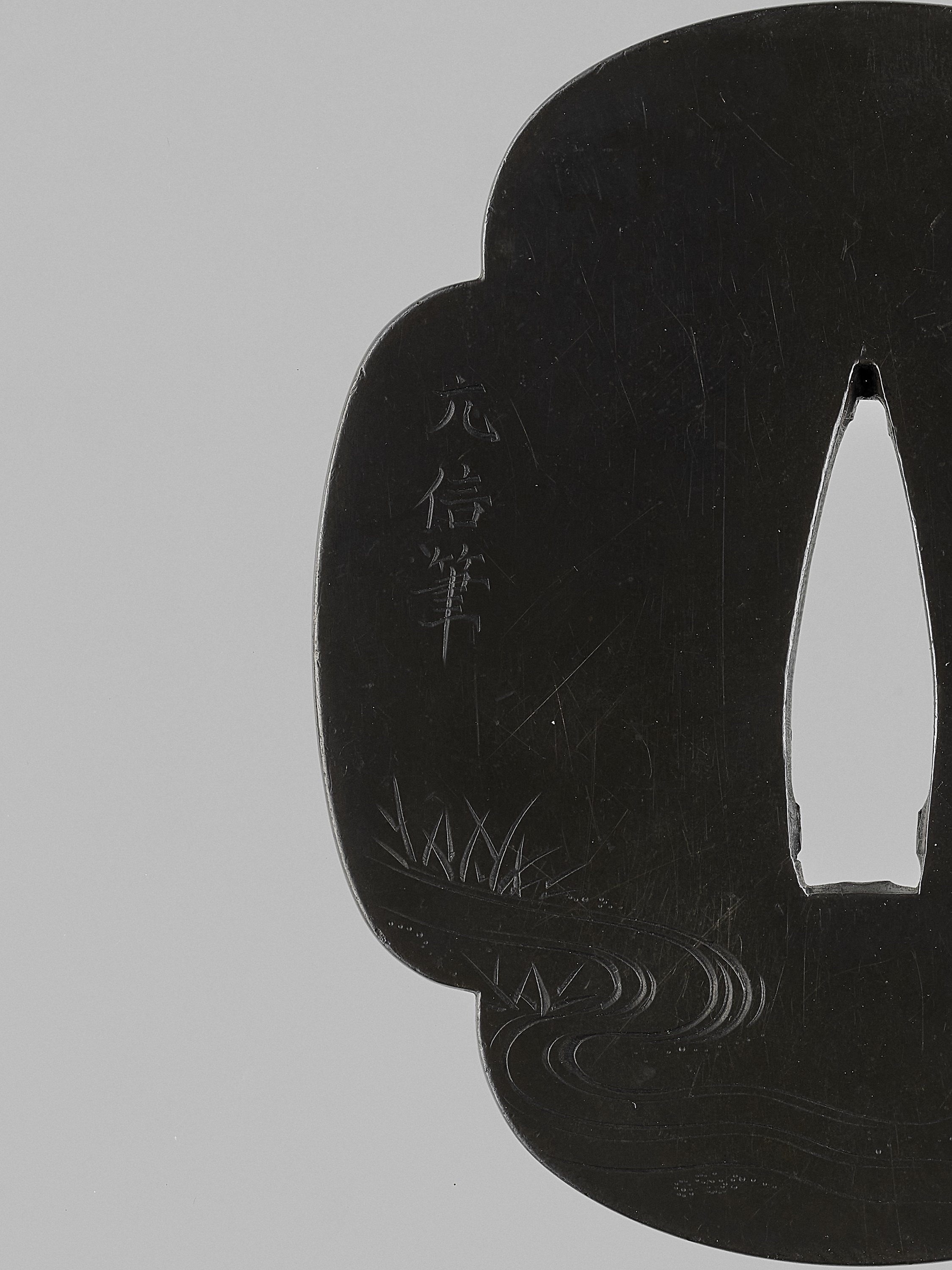 Lot 35 - MOTONOBU: A SHIBUICHI TSUBA WITH HOTEI