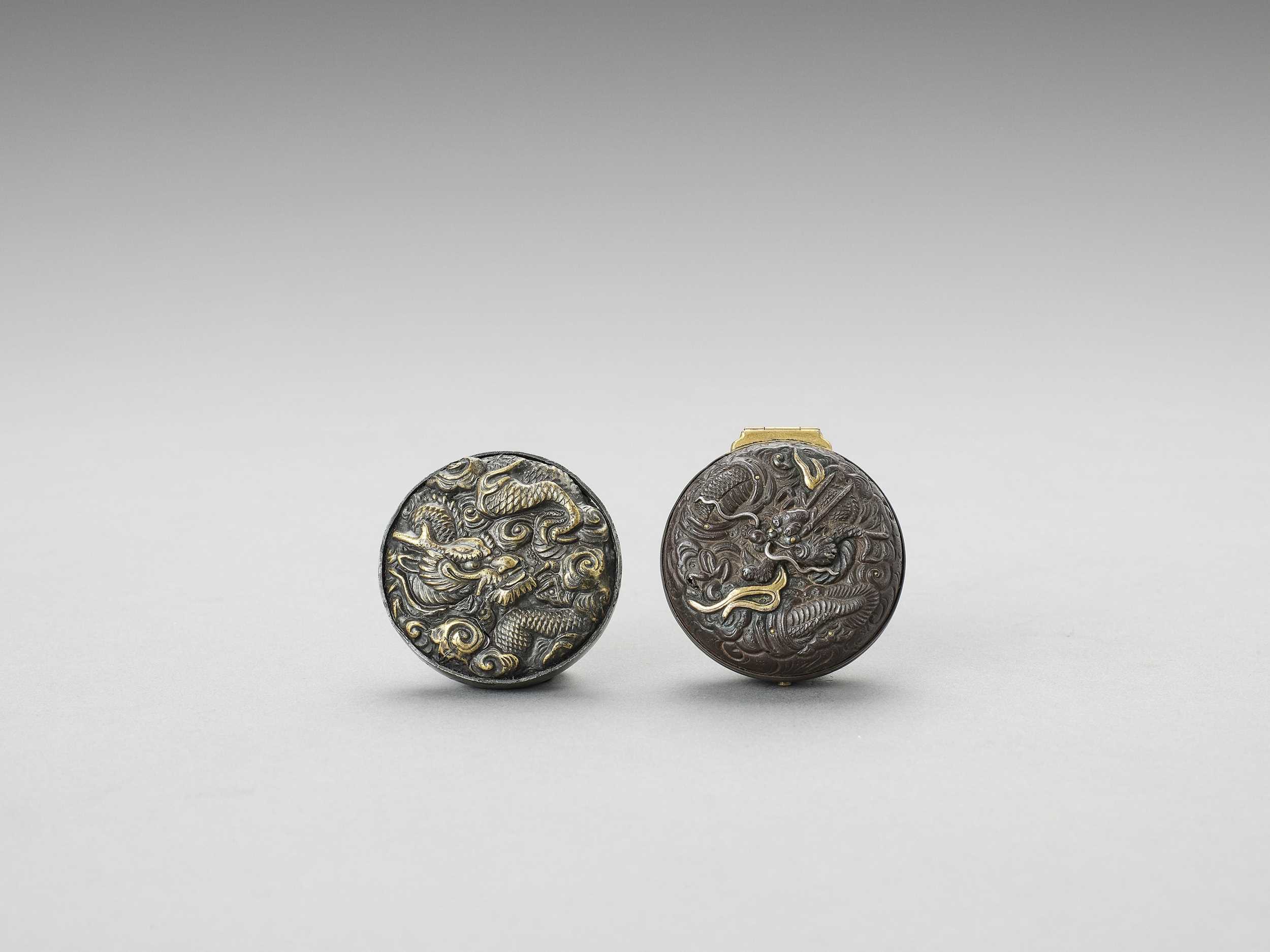Lot 334 - TWO PARCEL-GILT METAL MANJU NETSUKE WITH