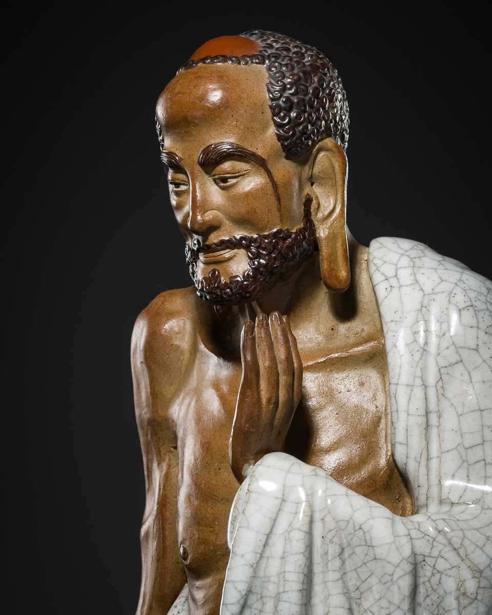Lot 550 - A SHIWAN WARE CERAMIC FIGURE OF SHAKYAMUNI,