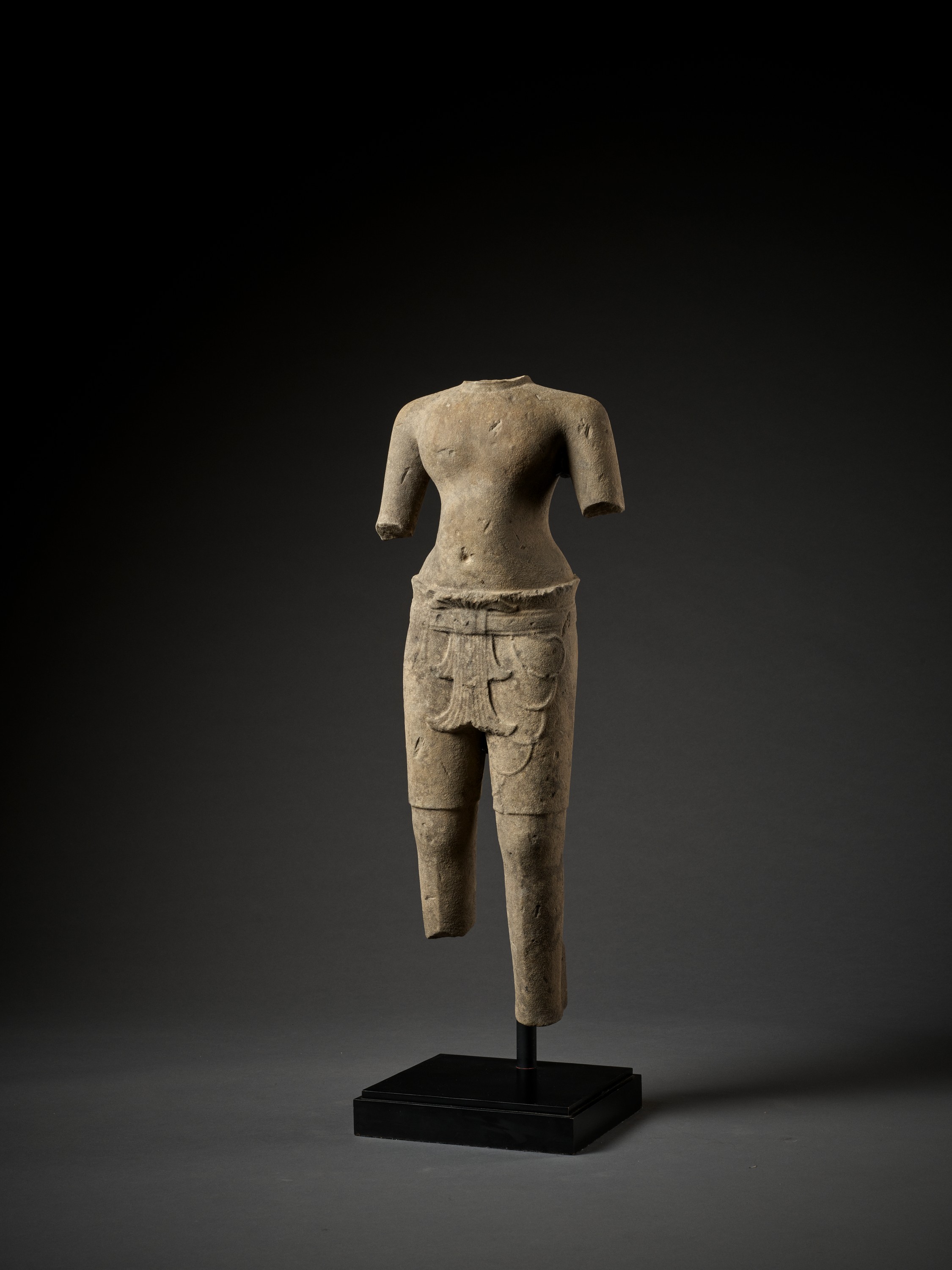 Lot 702 - A KHMER SANDSTONE TORSO OF A MALE DEITY,