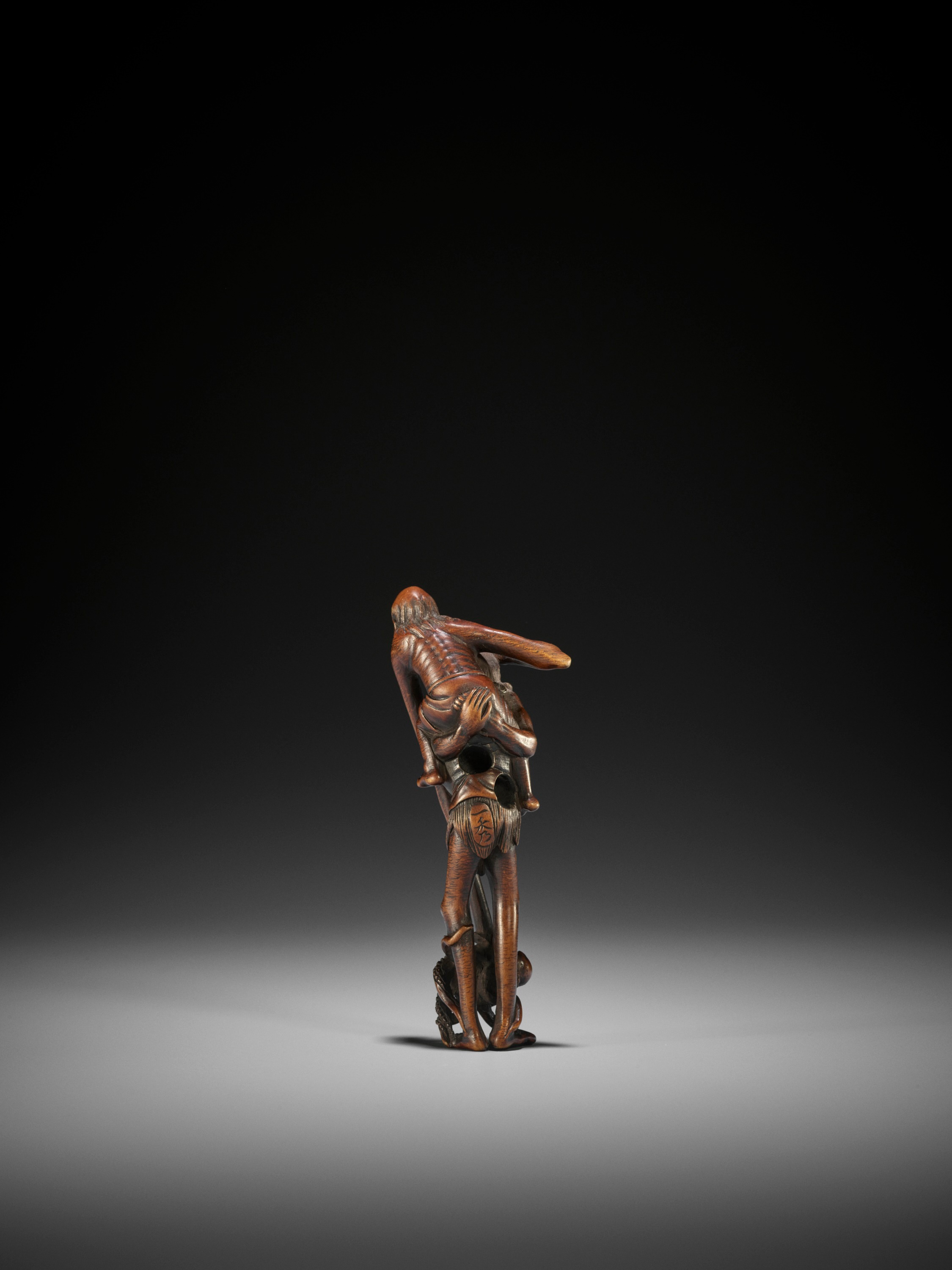 Lot 20 - KAZUHIDE: A TALL WOOD NETSUKE OF ASHINAGA AND