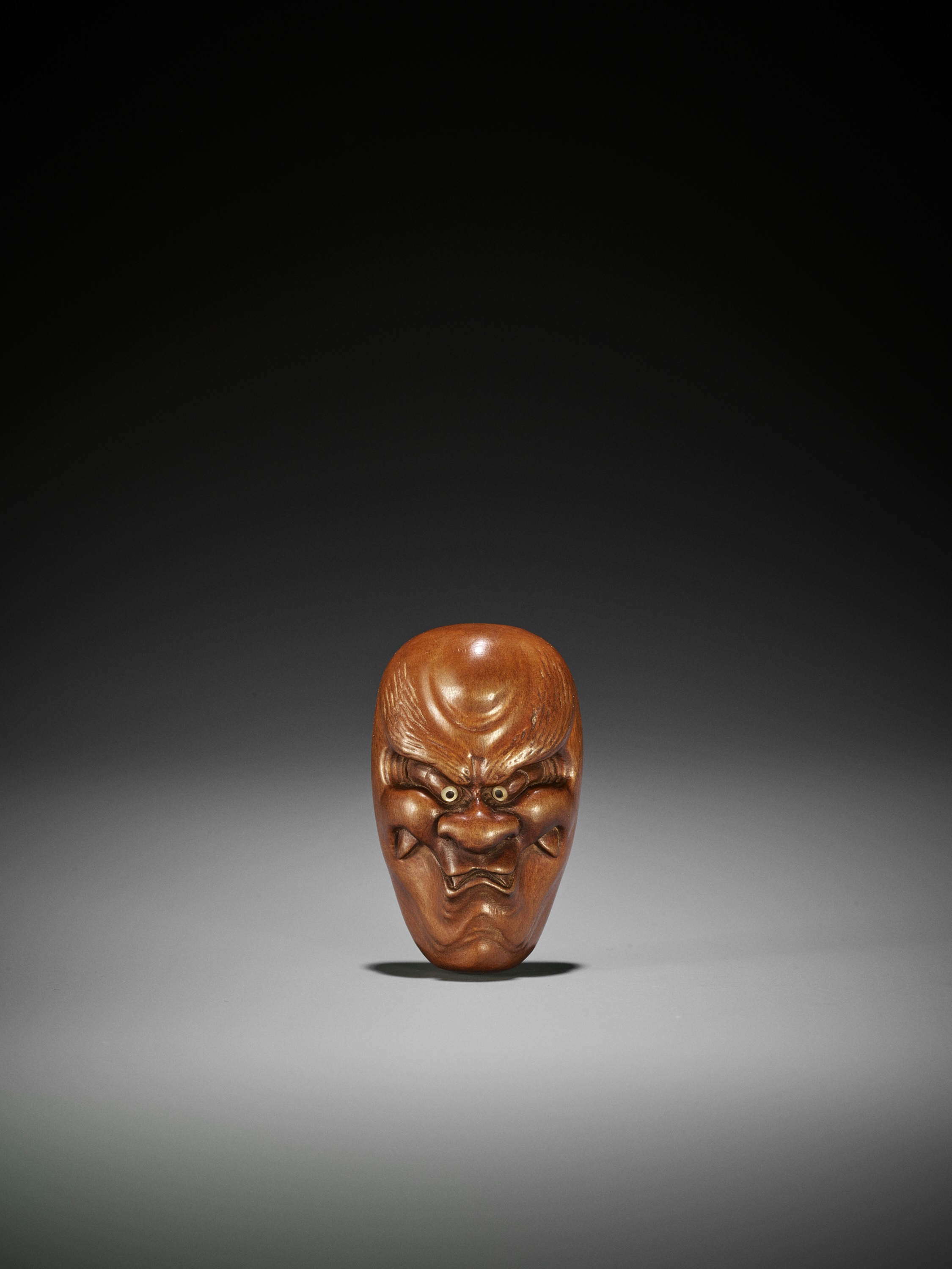 Lot 288 - HOZAN: A WOOD NETSUKE OF A BAKEMONO MASK