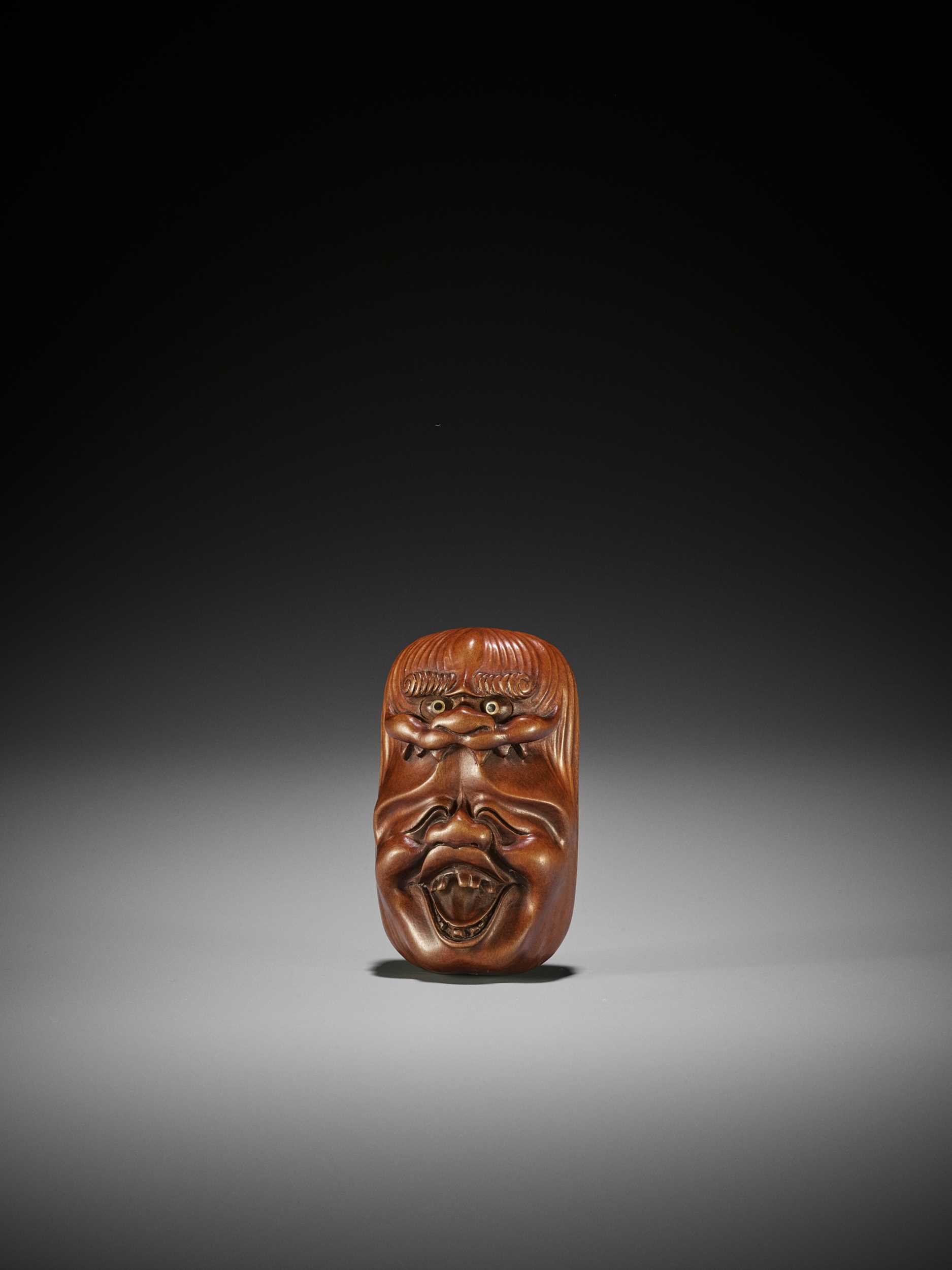 Lot 260 - HOZAN: A WOOD NETSUKE OF A TWO-FACED