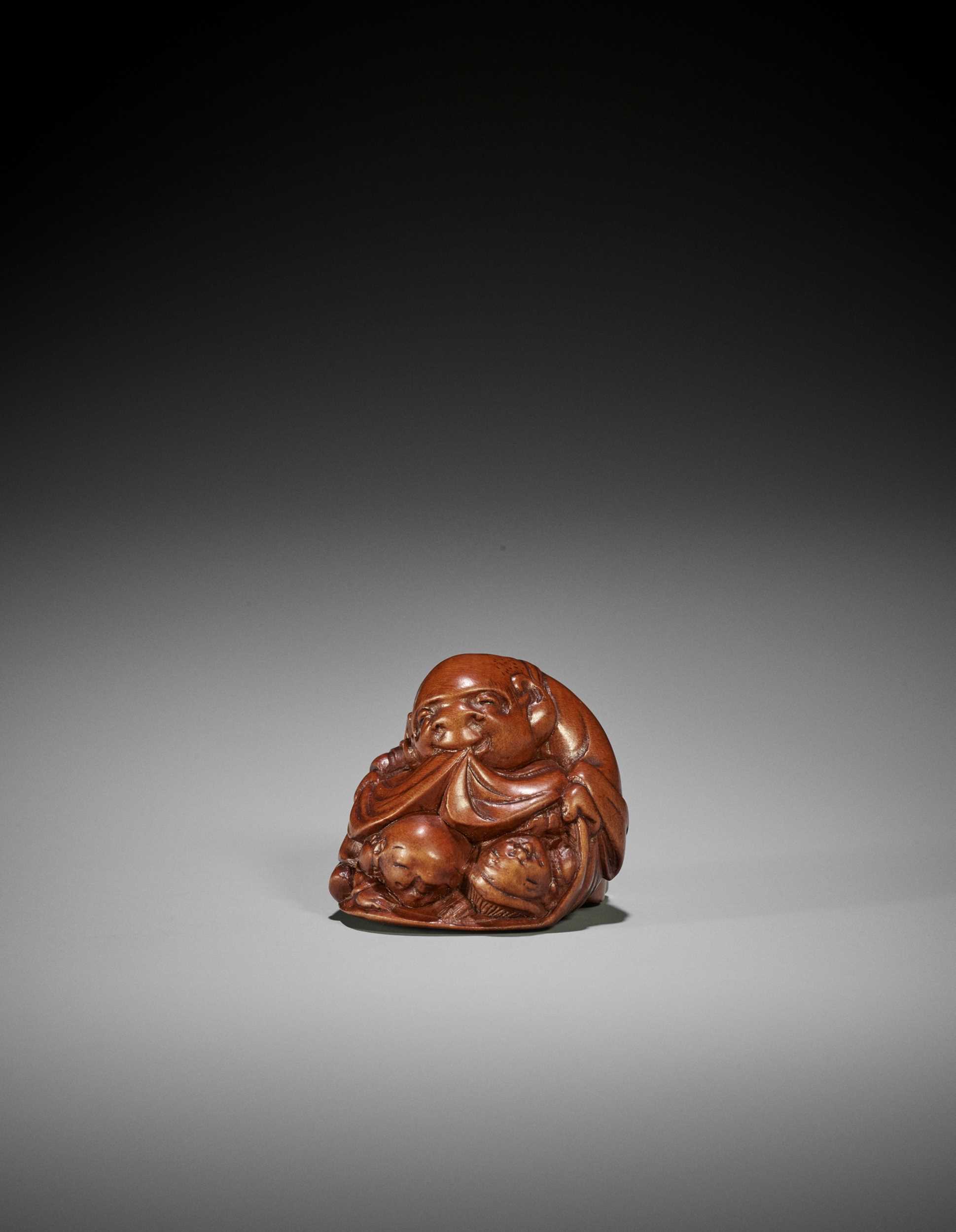 Lot 153 - OTOMAN: A MASTERFUL WOOD NETSUKE OF HOTEI