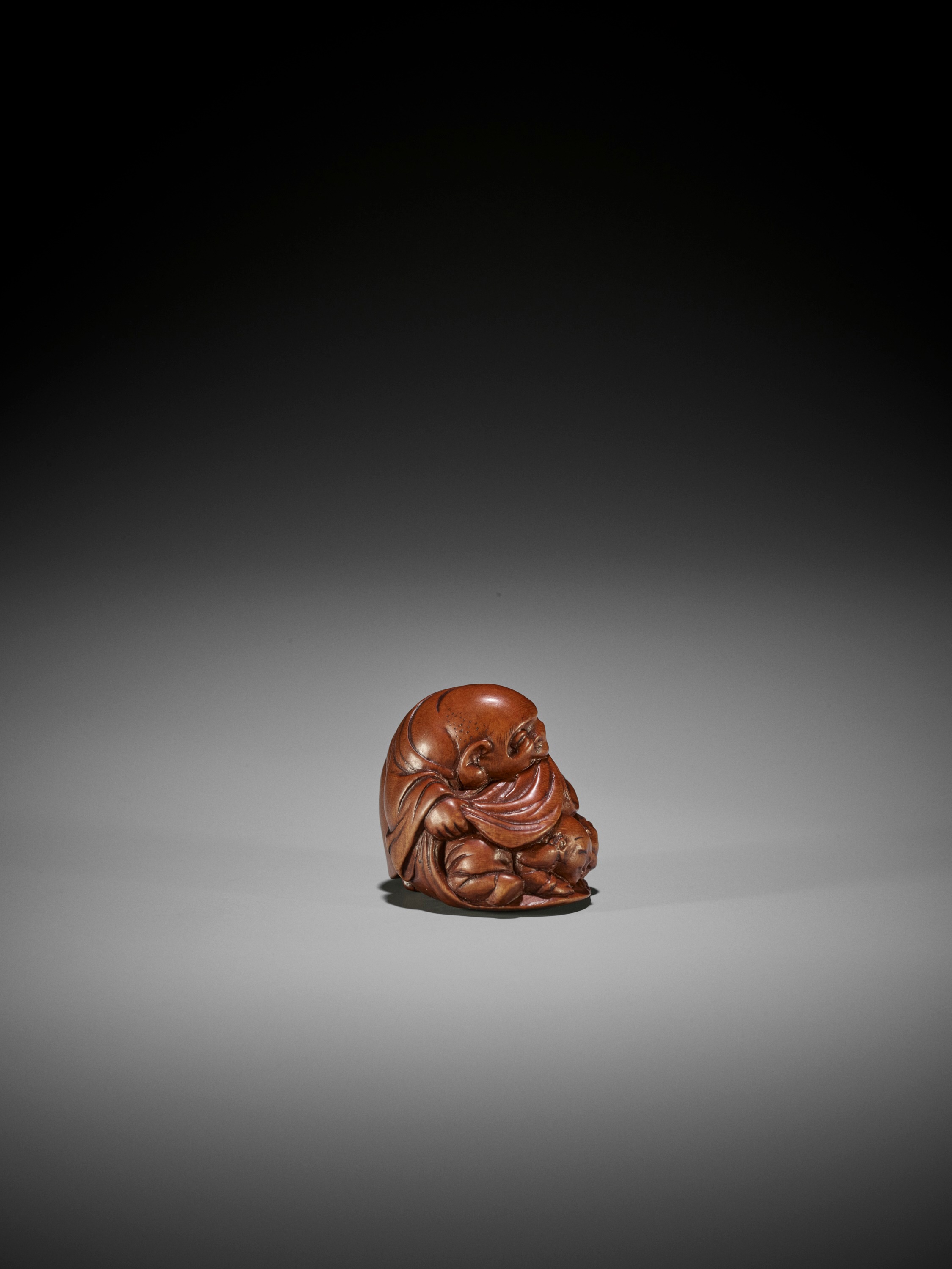 Lot 153 - OTOMAN: A MASTERFUL WOOD NETSUKE OF HOTEI
