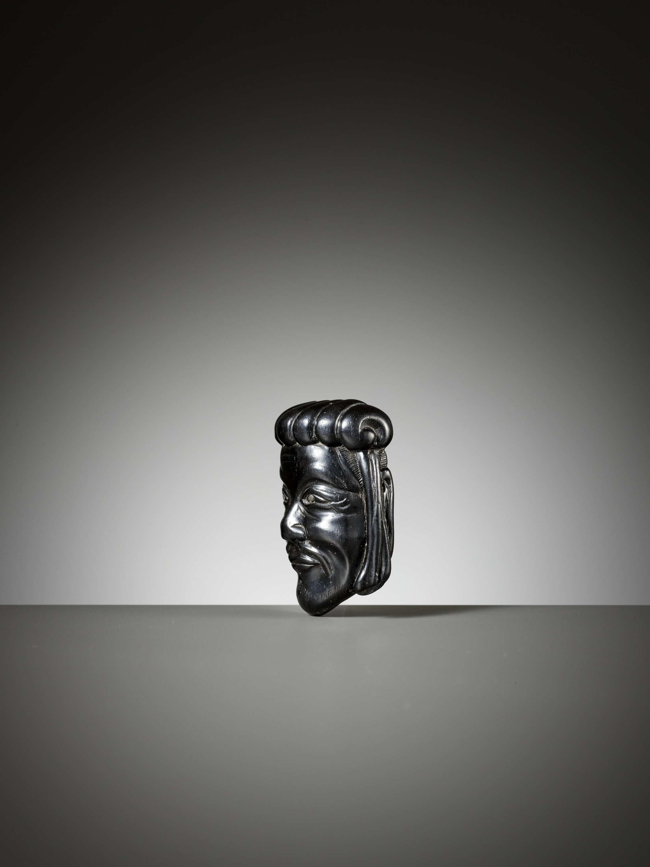 Lot 289 - A RARE EBONY GYODO (RELIGIOUS) MASK NETSUKE