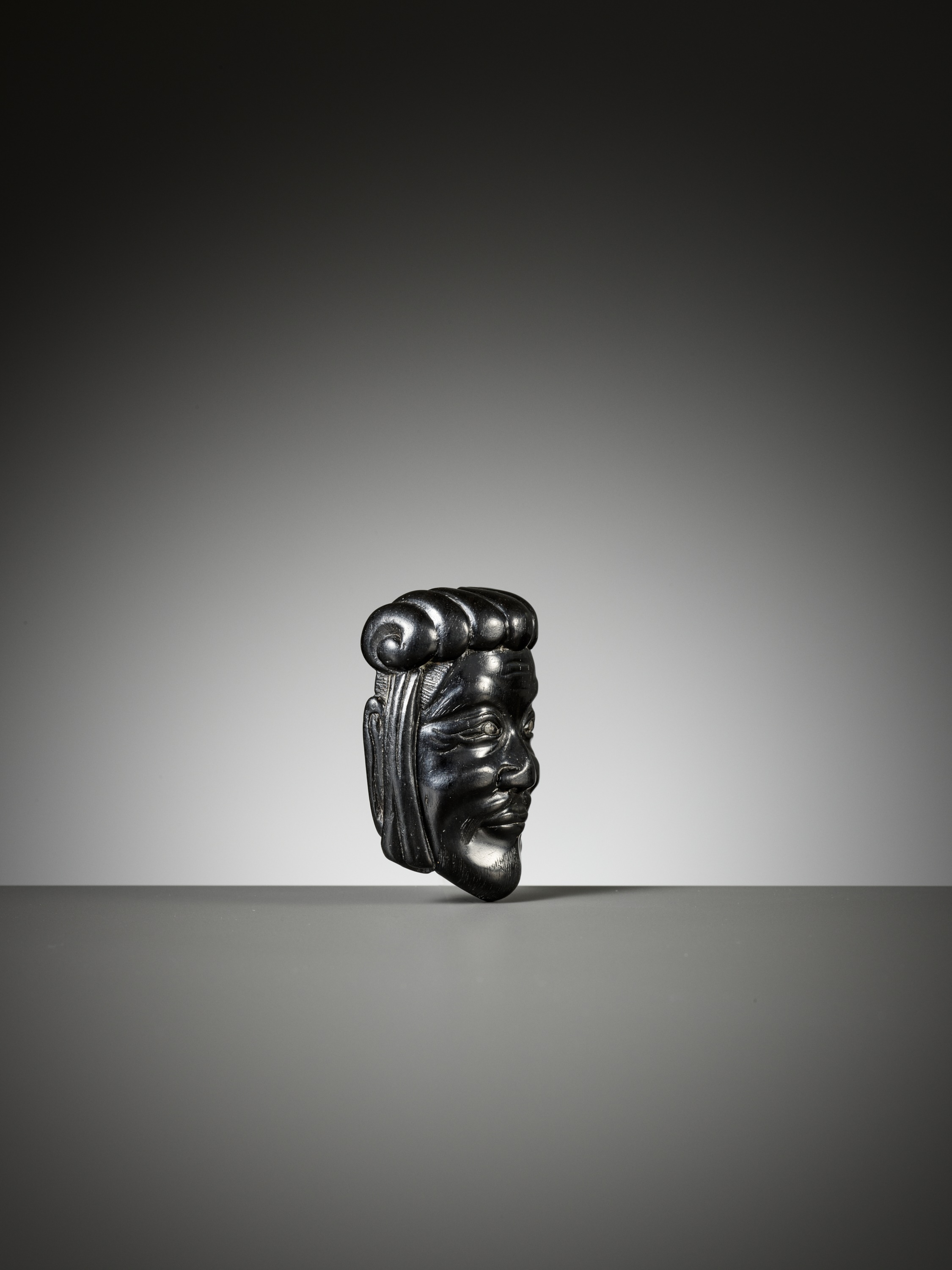 Lot 289 - A RARE EBONY GYODO (RELIGIOUS) MASK NETSUKE