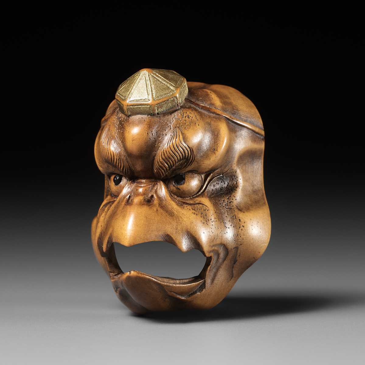 Lot 252 - A PALE BOXWOOD MASK NETSUKE OF A KARASU