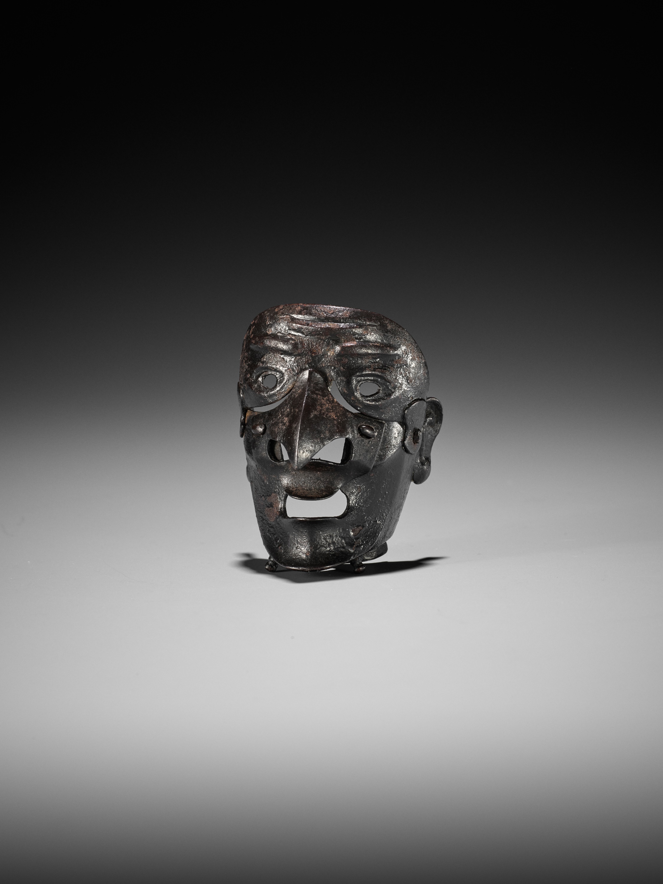 Lot 250 - A RARE LACQUERED IRON MASK NETSUKE DEPICTING