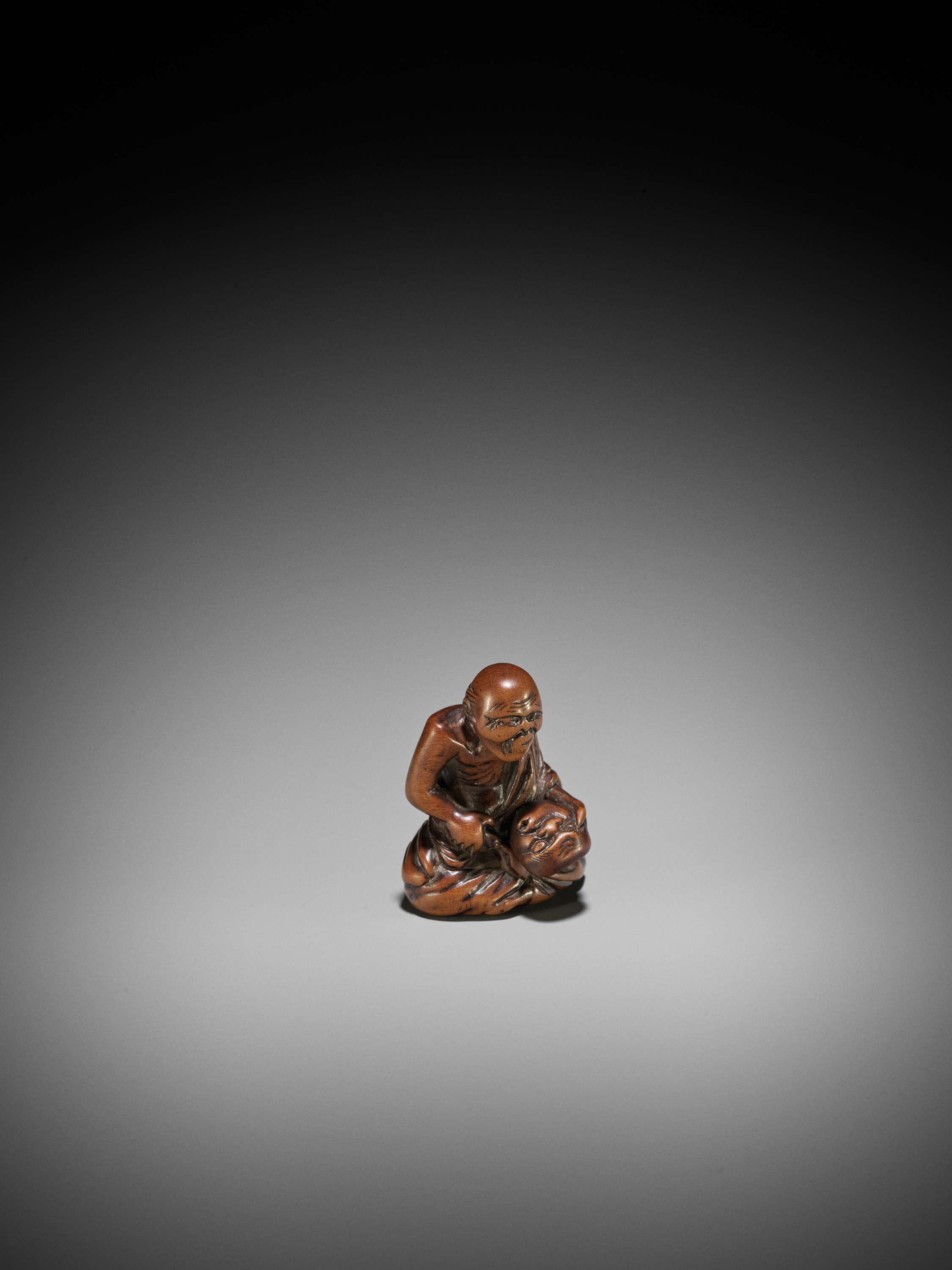 Lot 158 - A FINE EDO SCHOOL WOOD NETSUKE OF A MASK