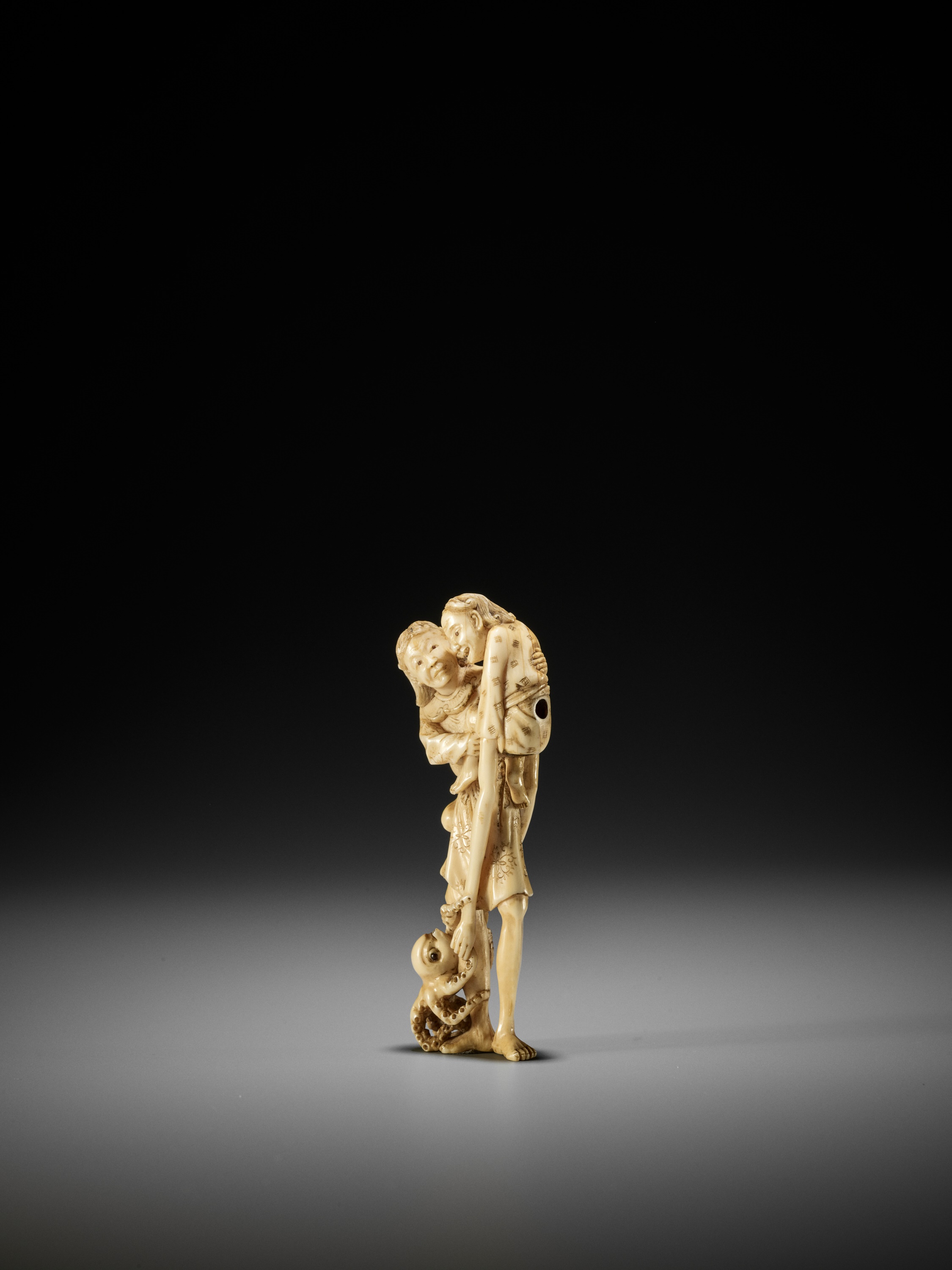 Lot 67 - HIDEMASA: A TALL IVORY NETSUKE OF ASHINAGA