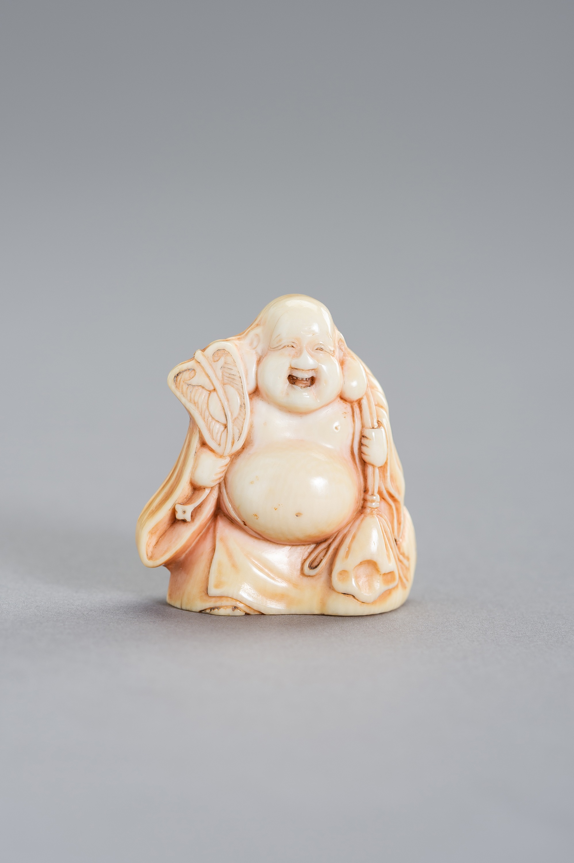 Lot 539 - UEDA KOHOSAI: AN IVORY NETSUKE OF A BIZEN