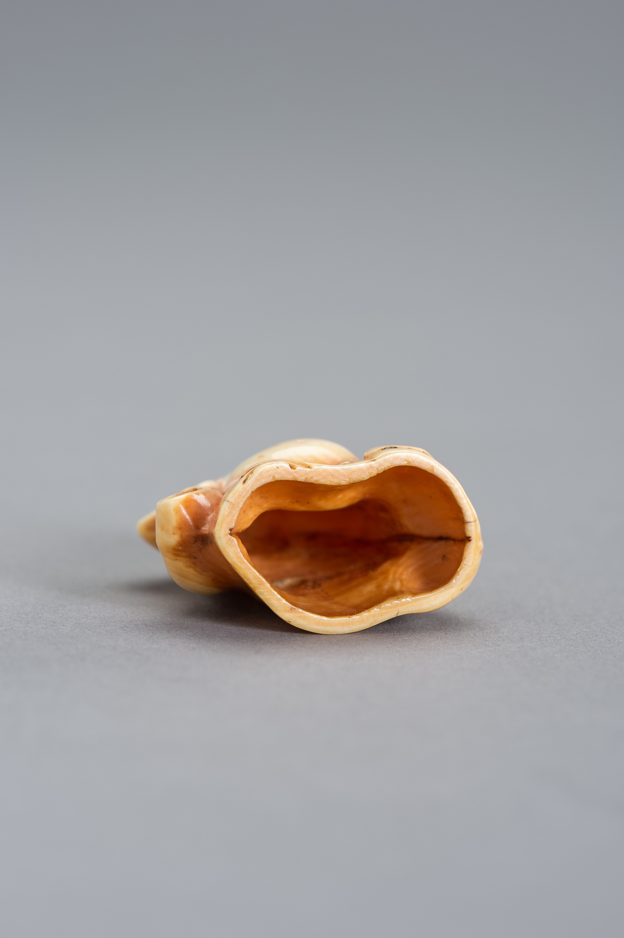 Lot 539 - UEDA KOHOSAI: AN IVORY NETSUKE OF A BIZEN