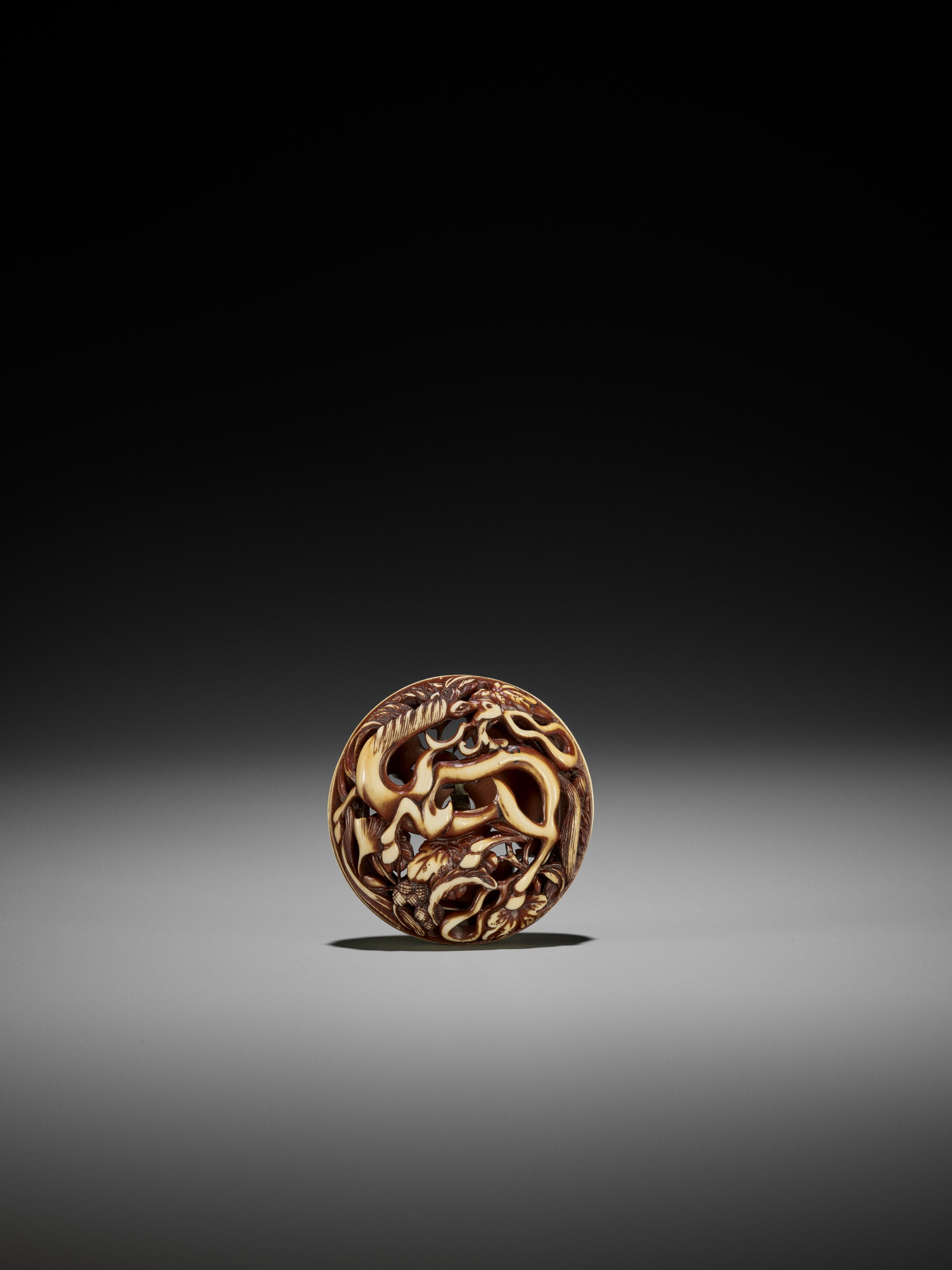 Lot 184 - ICHIYUSAI: A RARE IVORY RYUSA MANJU NETSUKE