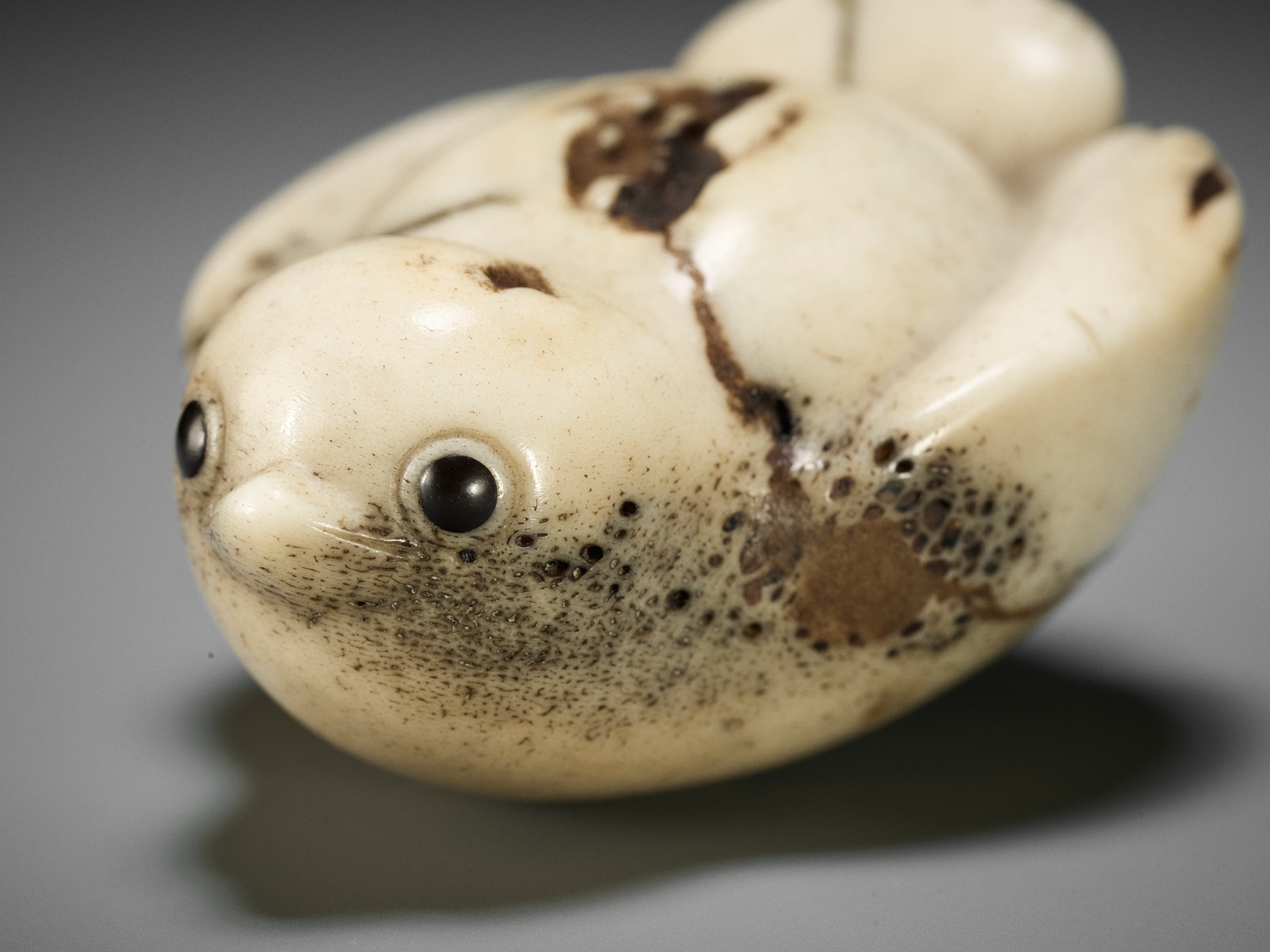 Lot 212 - MASATOSHI: A STAG ANTLER NETSUKE OF A FUKURA