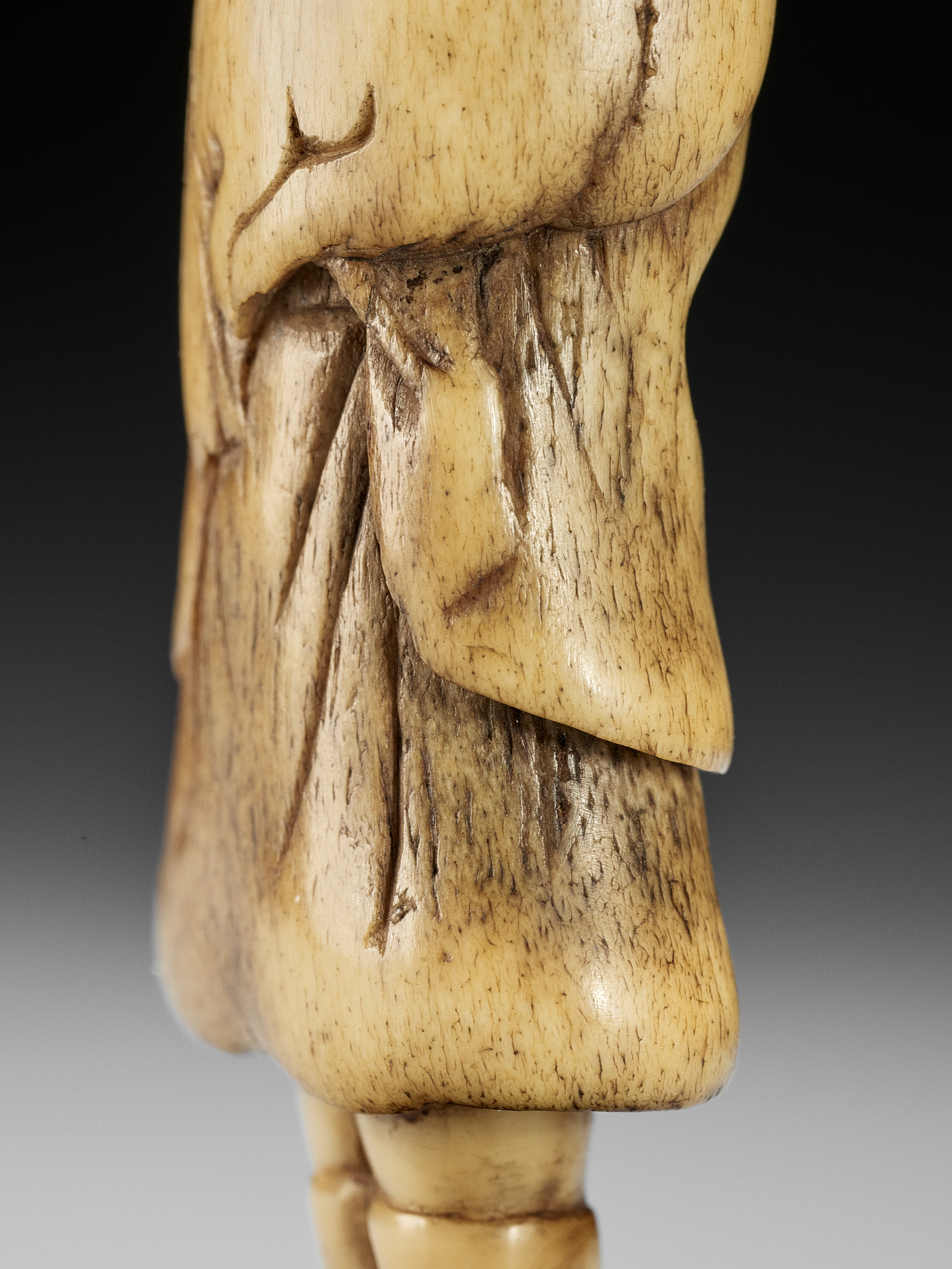Lot 228 - A RARE STAG ANTLER NETSUKE OF A DUTCHMAN