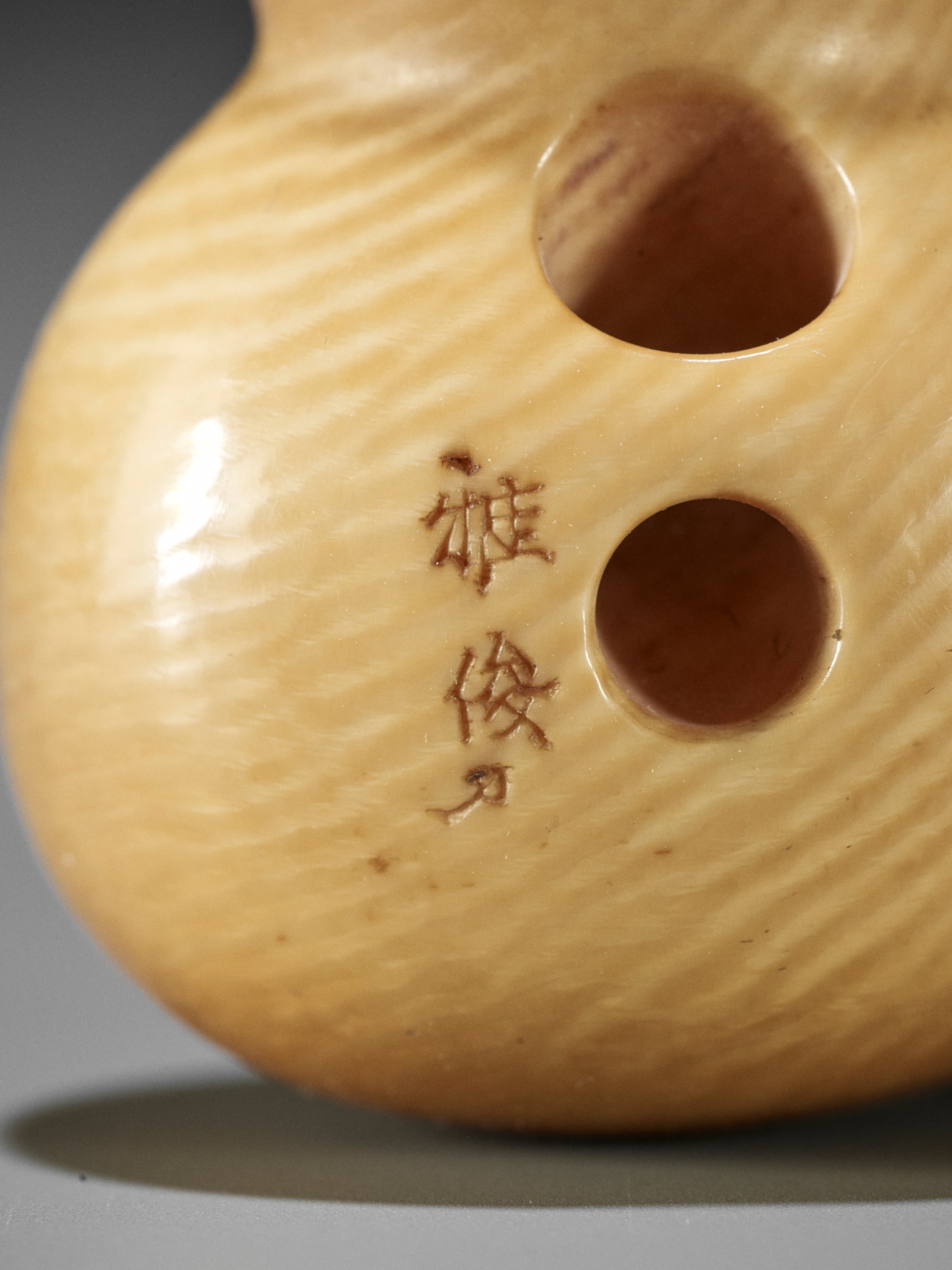 Lot 213 - MASATOSHI: AN UNUSUAL IVORY NETSUKE OF