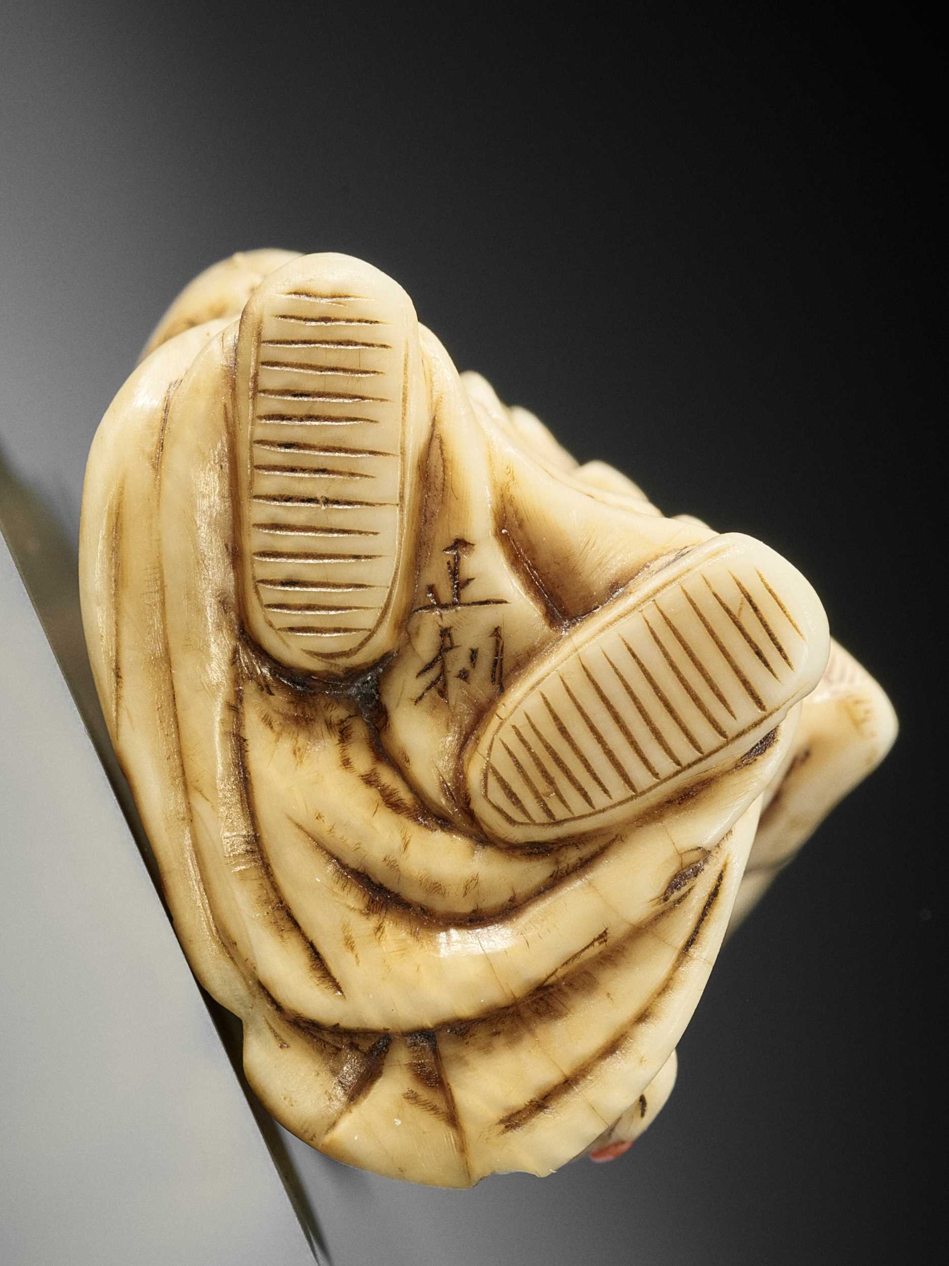 Lot 240 - MASATOSHI: AN IVORY NETSUKE OF GATTEN WITH A