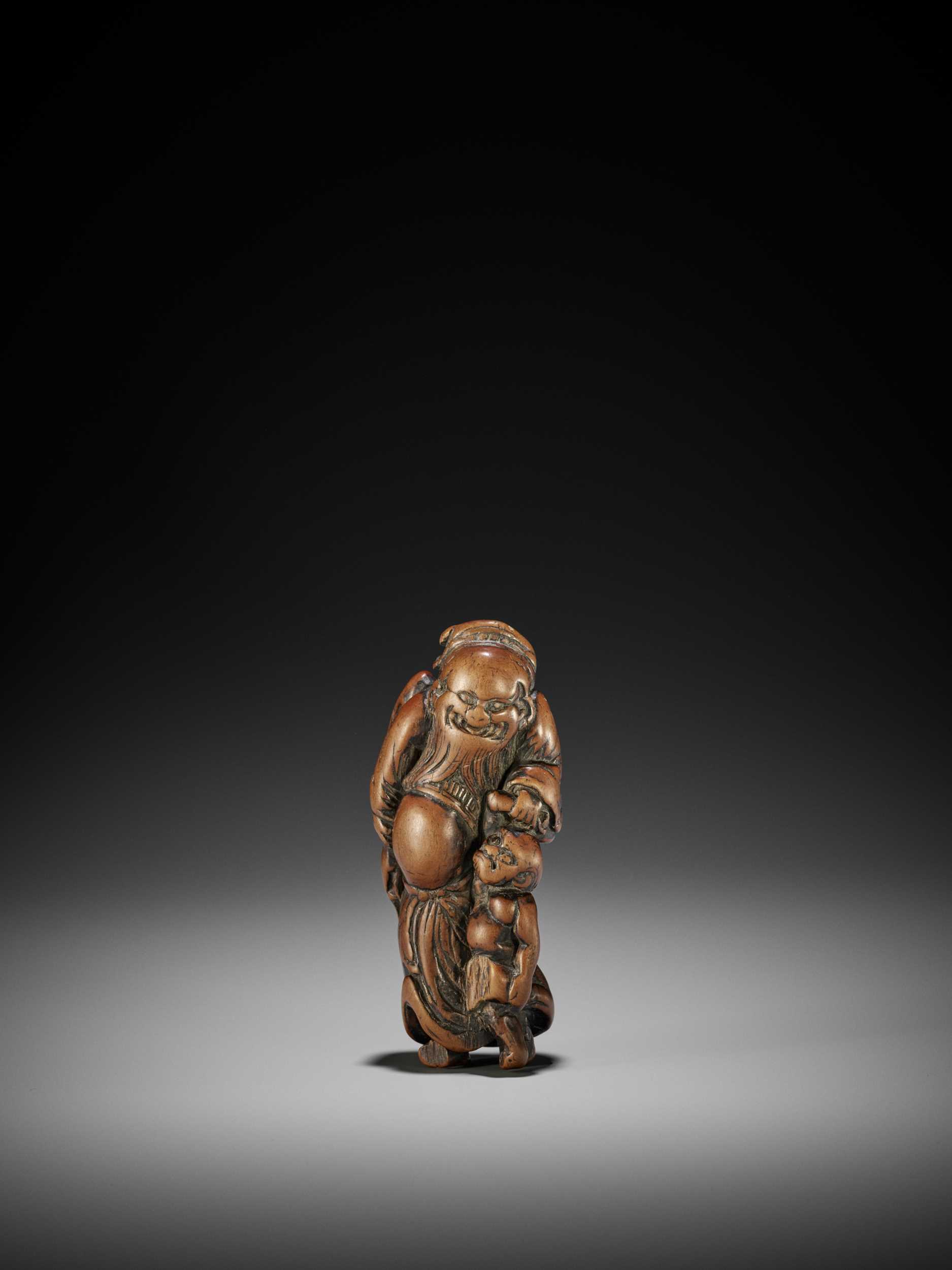 Lot 10 - A LARGE WOOD NETSUKE OF SHOKI AND ONI