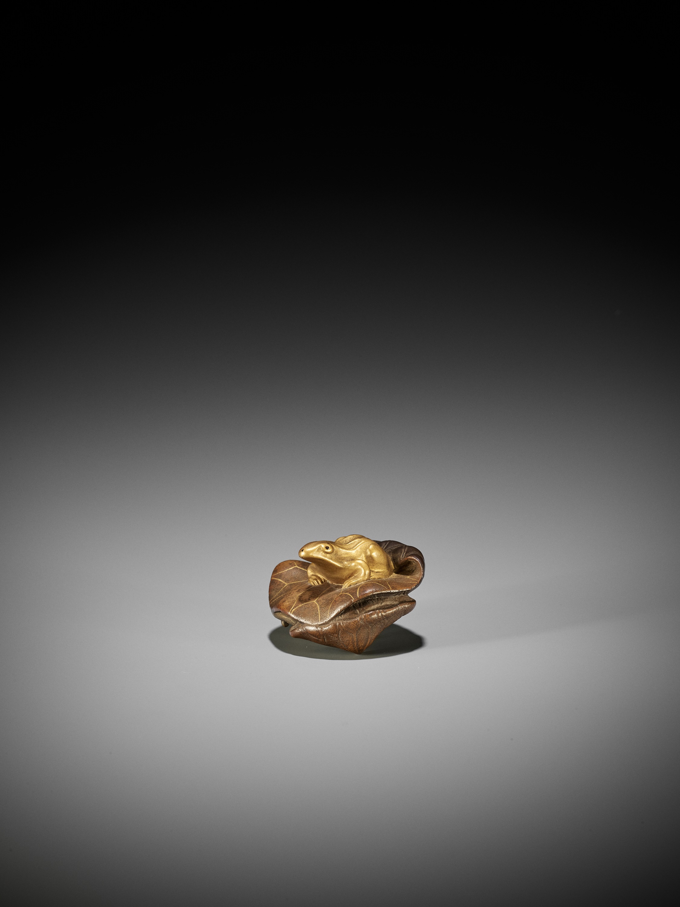 Lot 85 - TOMONOBU: A RARE LACQUERED WOOD NETSUKE OF A