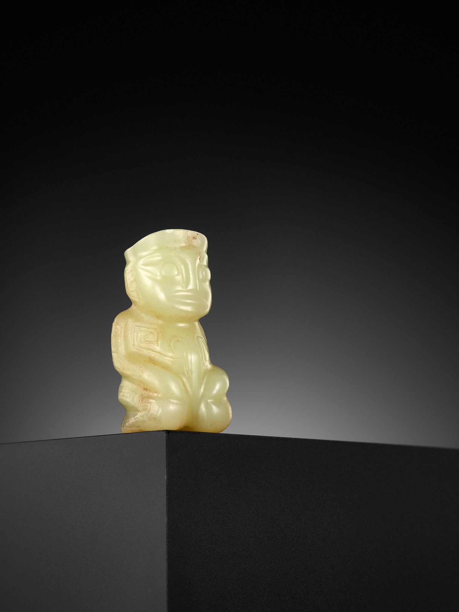 Lot 48 - AN EXTREMELY RARE YELLOW JADE ‘KNEELING