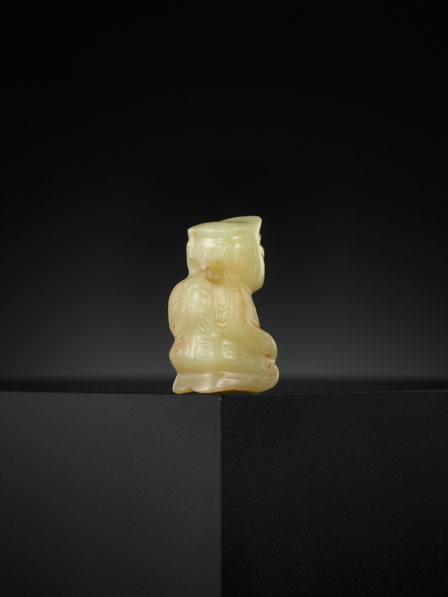 Lot 48 - AN EXTREMELY RARE YELLOW JADE ‘KNEELING