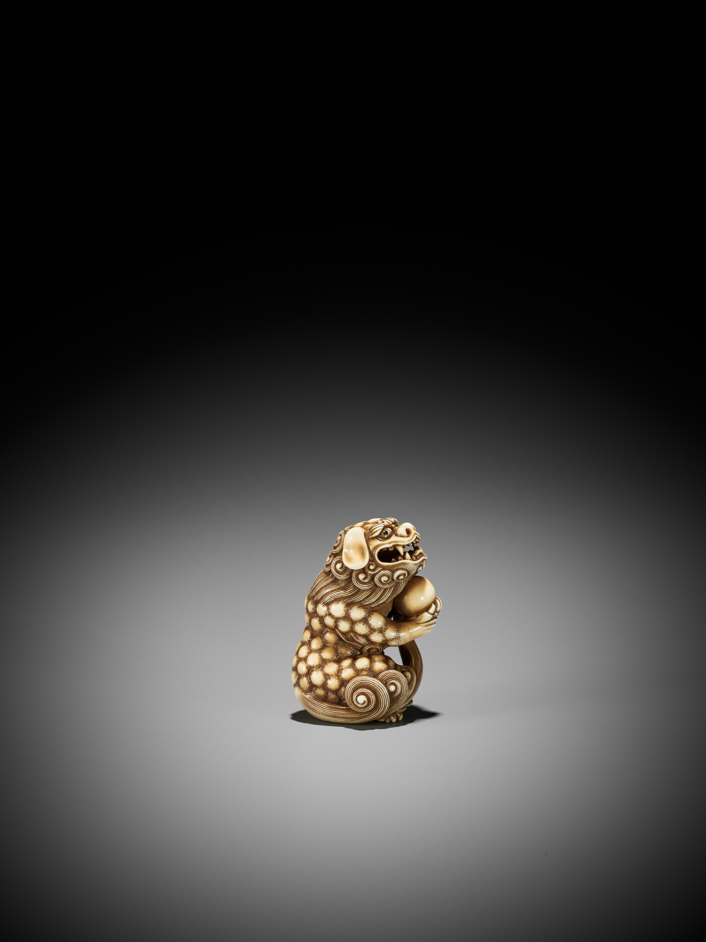 Lot 214 - MASATOSHI: A FINE IVORY NETSUKE OF A SHISHI