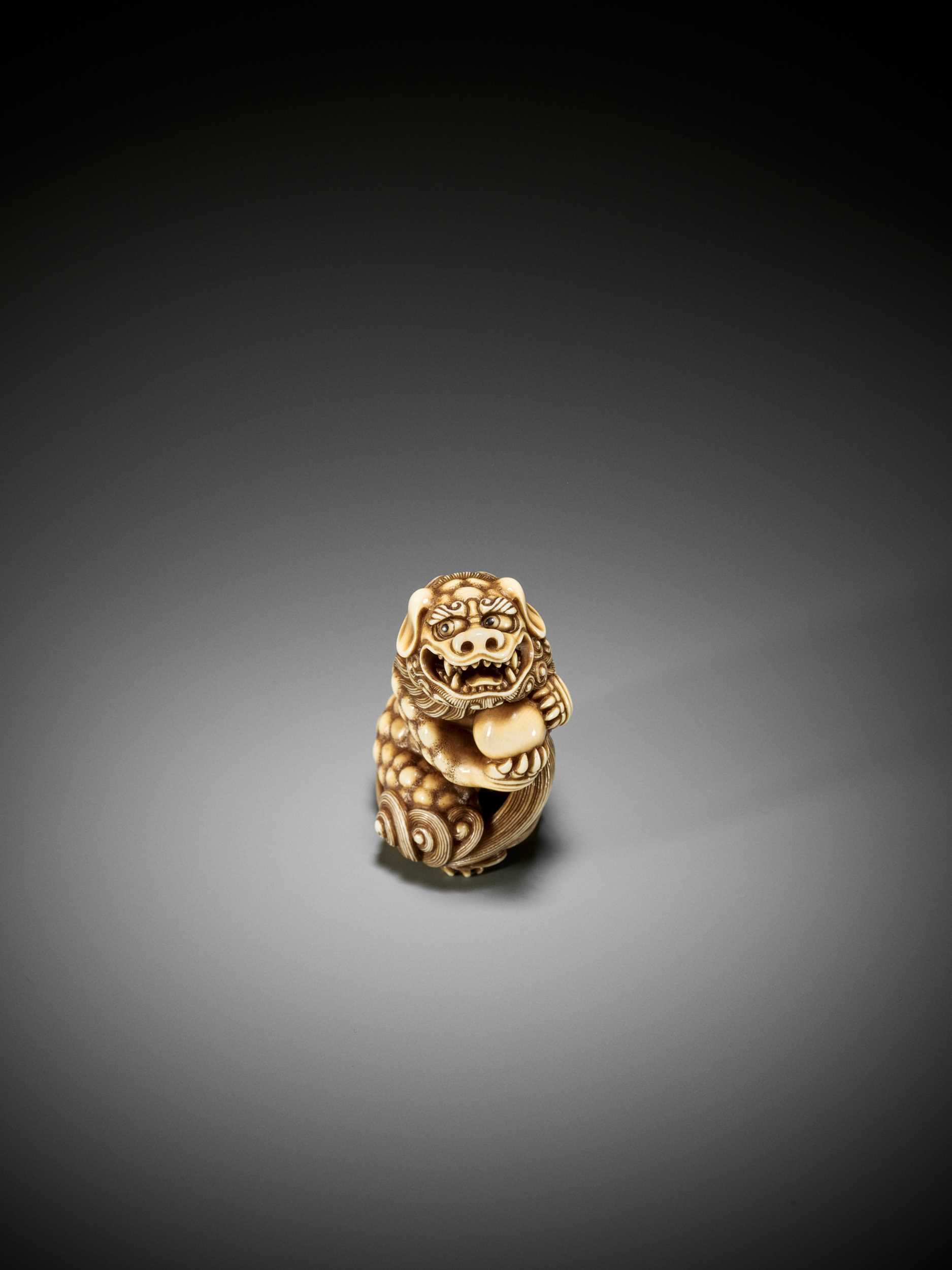 Lot 214 - MASATOSHI: A FINE IVORY NETSUKE OF A SHISHI