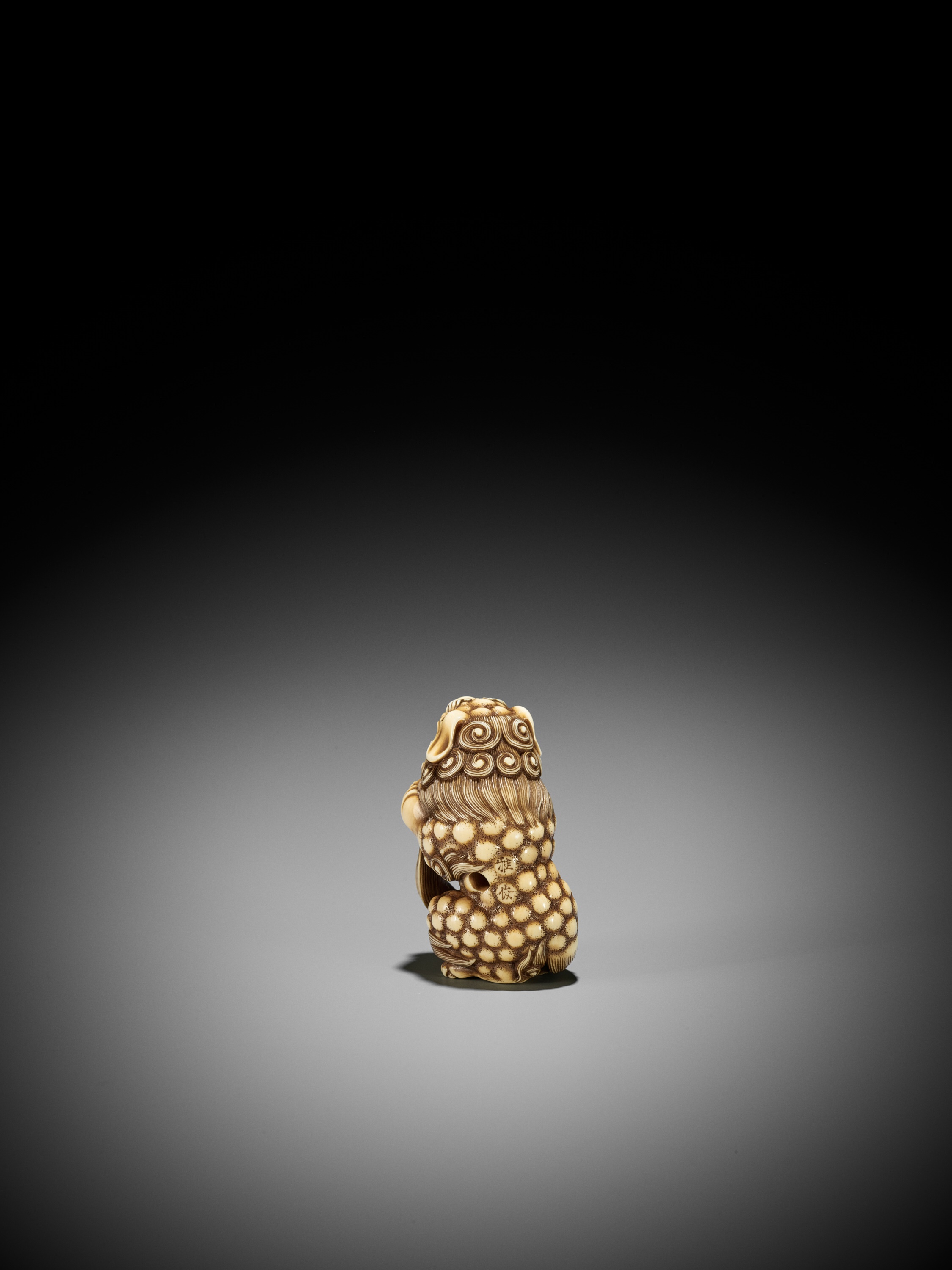 Lot 214 - MASATOSHI: A FINE IVORY NETSUKE OF A SHISHI