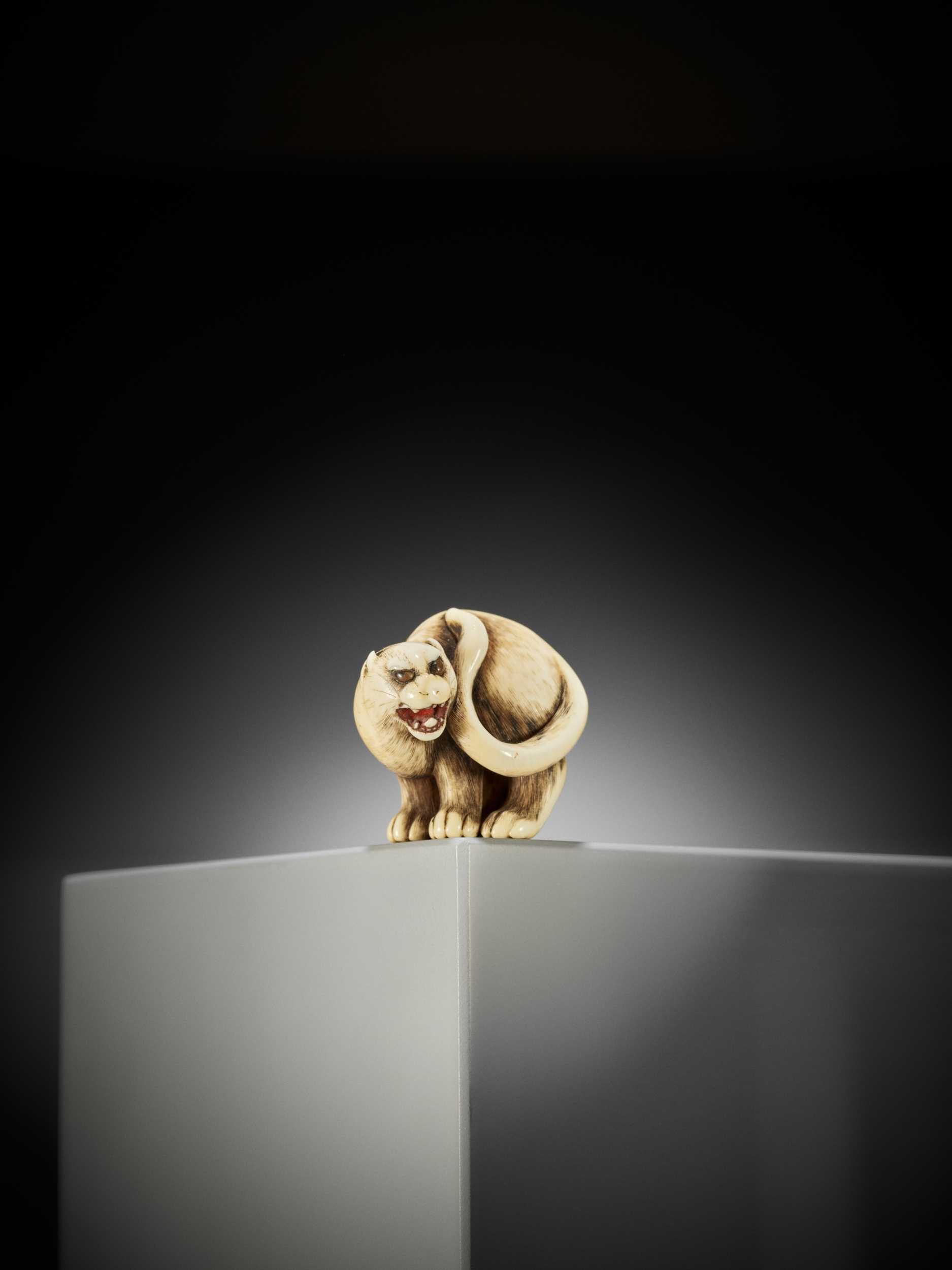 Lot 134 - OTOMAN: A SUPERB IVORY NETSUKE OF A TIGER