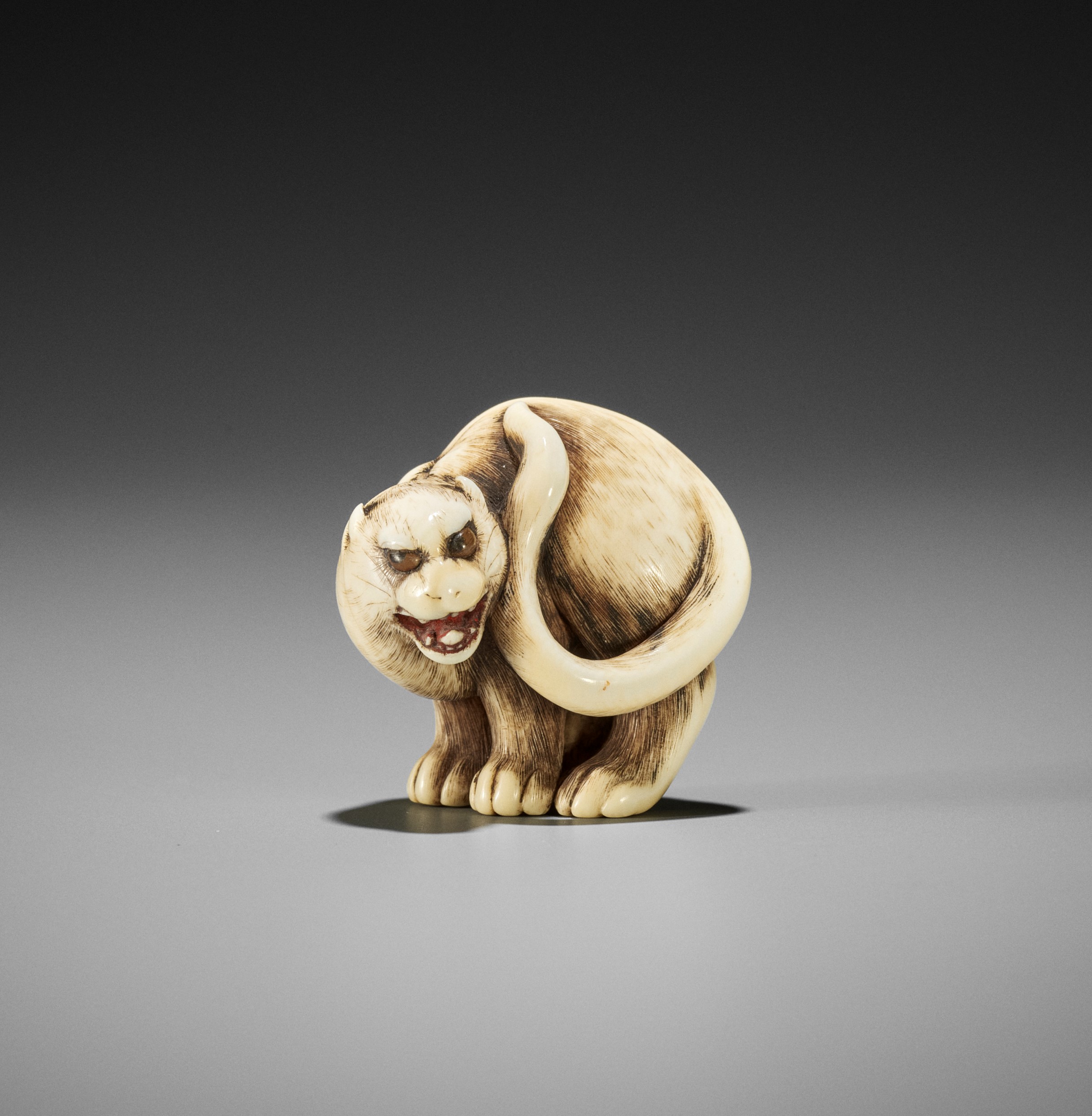Lot 134 - OTOMAN: A SUPERB IVORY NETSUKE OF A TIGER