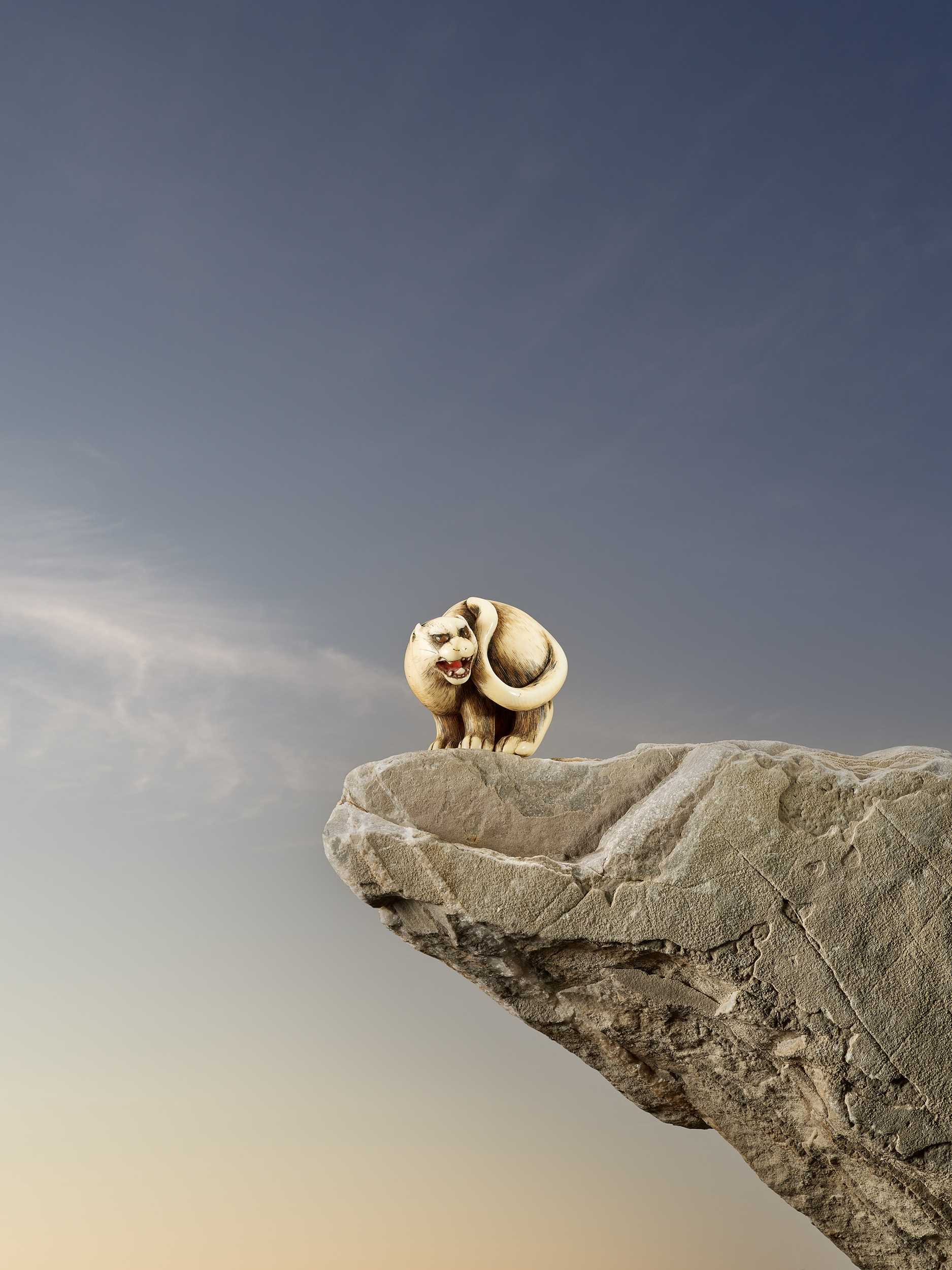 Lot 134 - OTOMAN: A SUPERB IVORY NETSUKE OF A TIGER