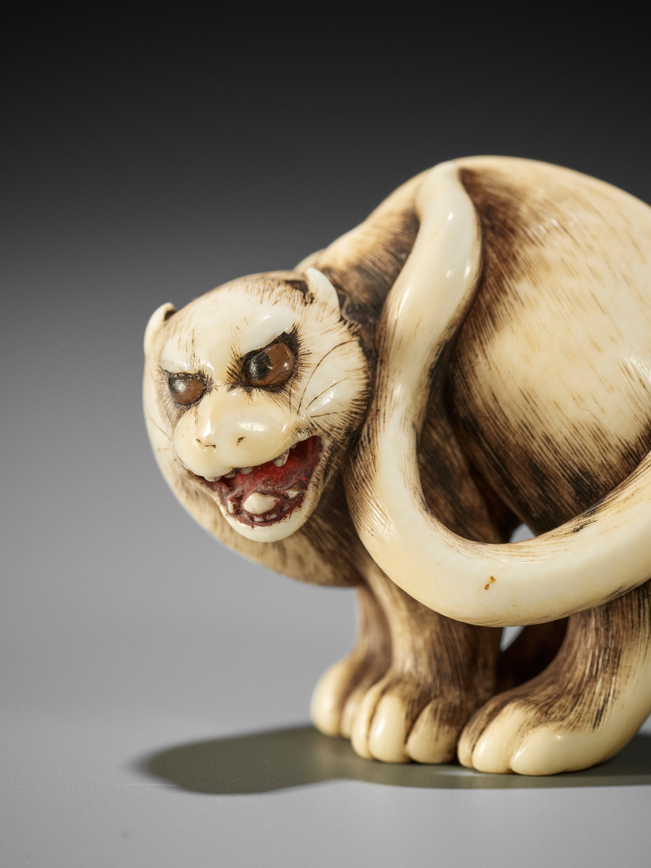 Lot 134 - OTOMAN: A SUPERB IVORY NETSUKE OF A TIGER