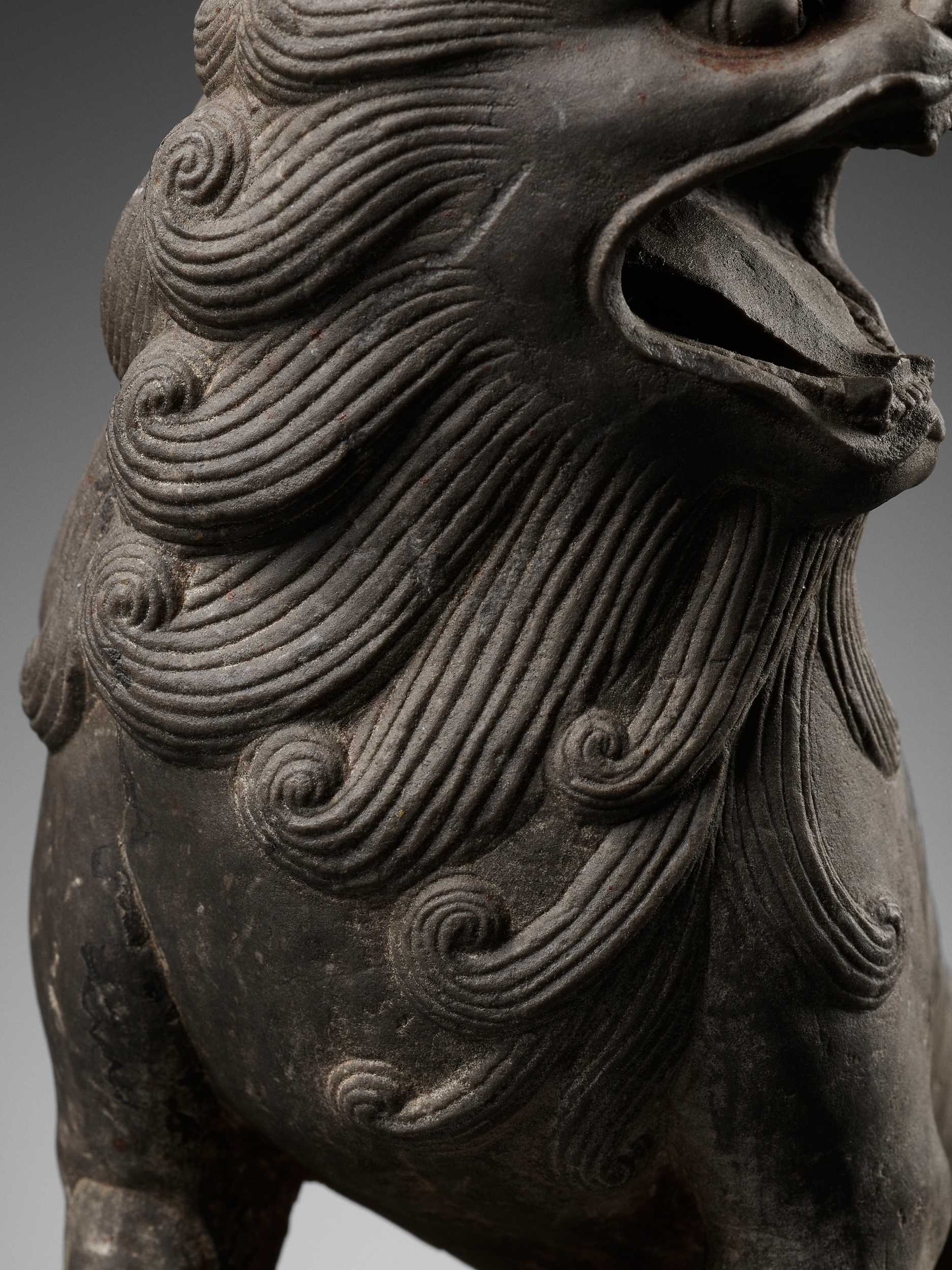 Lot 376 - A SUPERBLY CARVED LIMESTONE FIGURE OF A LION,